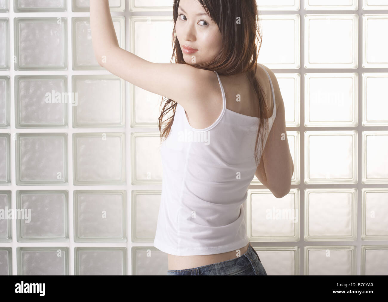 Woman looking over shoulder Stock Photo - Alamy