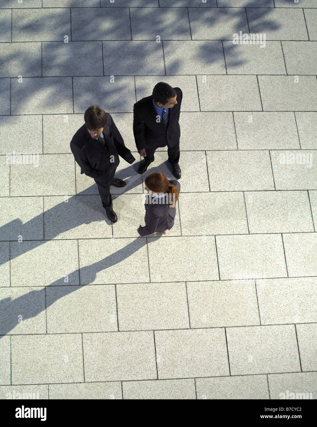 Three business people standing together Stock Photo - Alamy