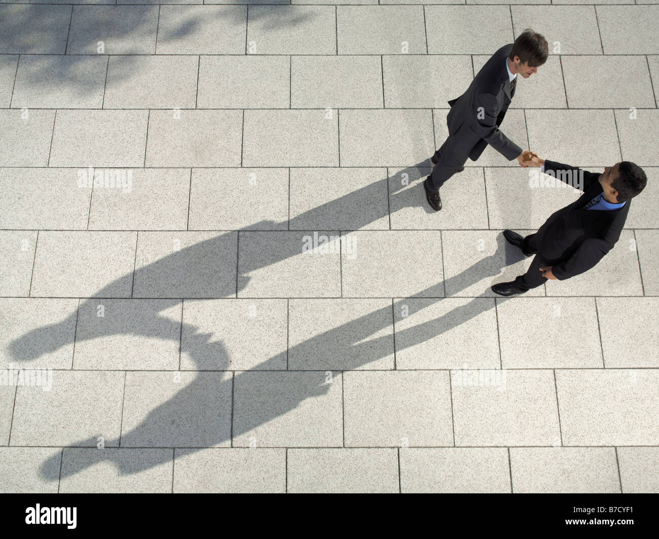 Businessmen shaking hands shadow hi-res stock photography and images ...