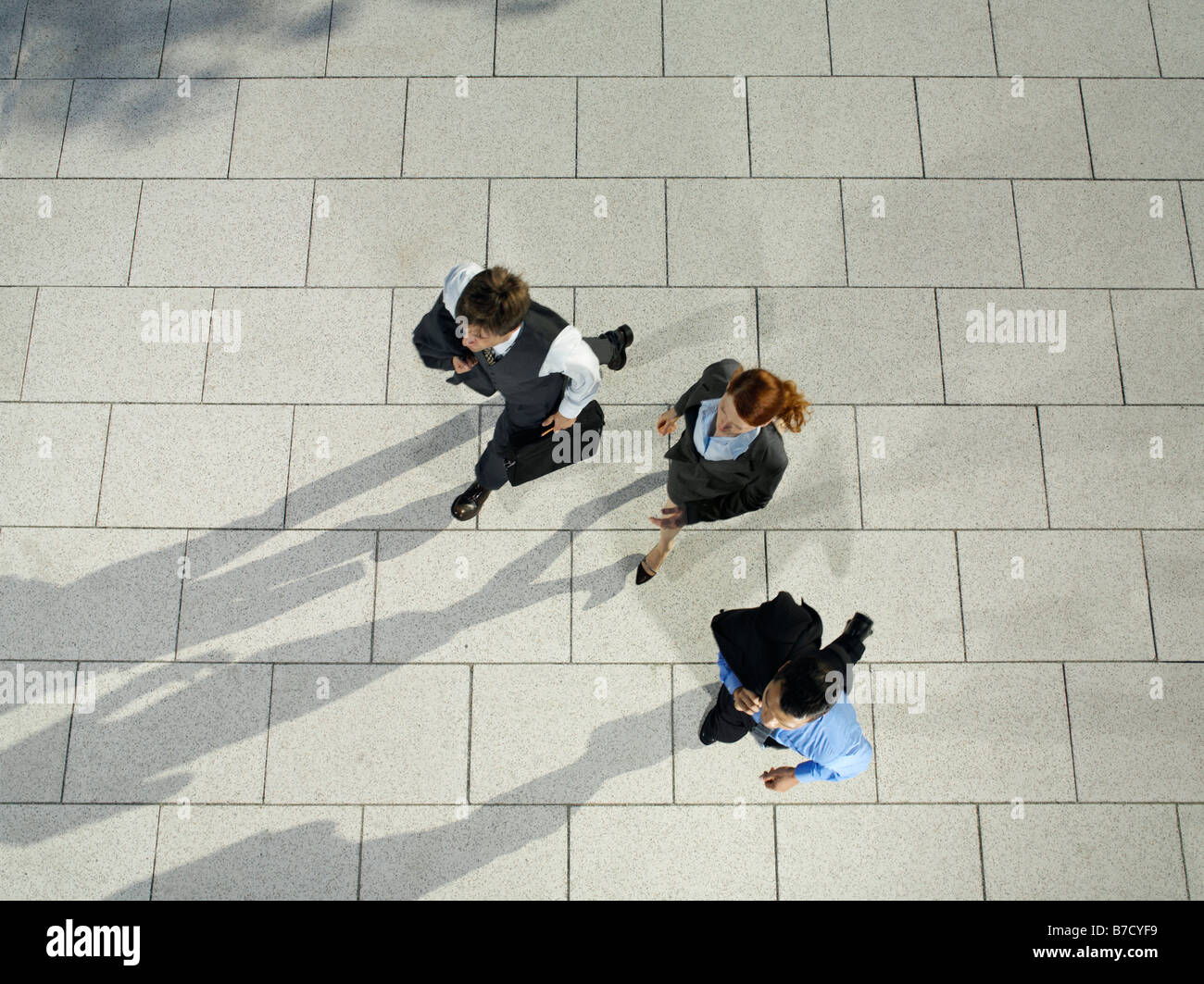Three business people running Stock Photo - Alamy