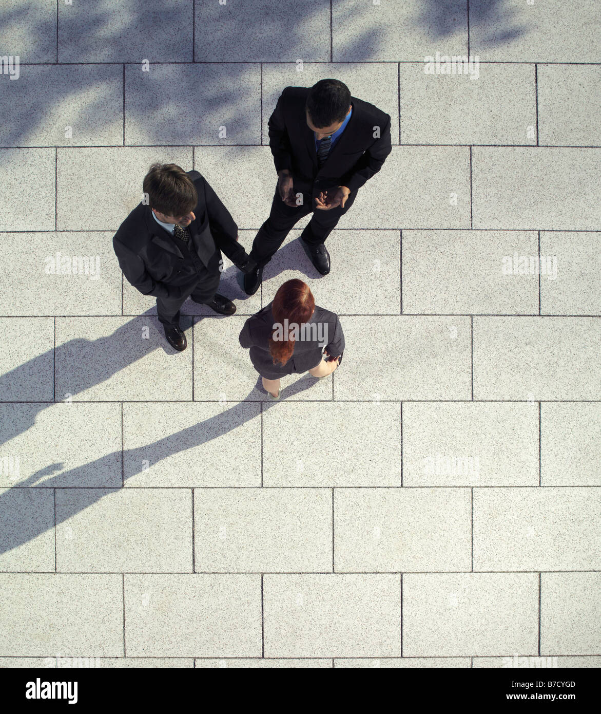 Three business people talking outdoors Stock Photo - Alamy
