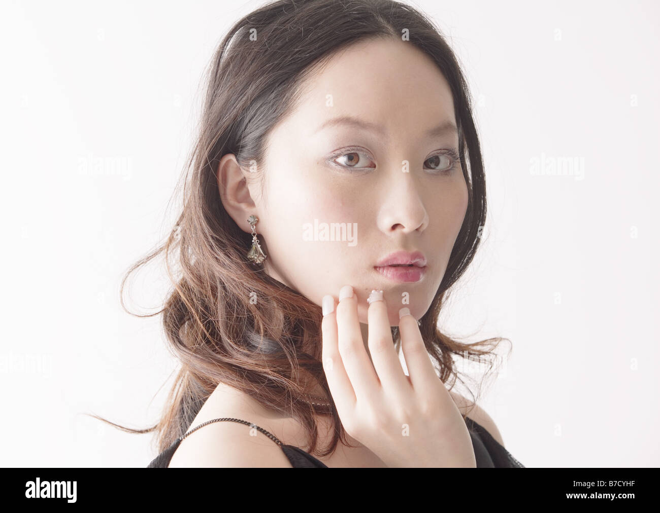 Woman with hand on face Stock Photo - Alamy