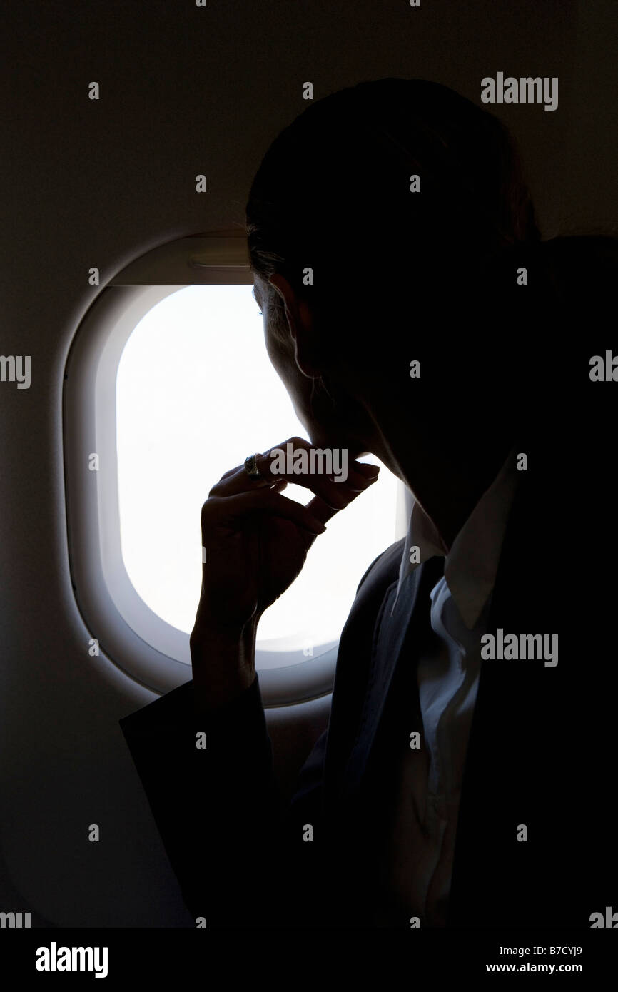 Woman Looking Through Window Of Plane Stock Photos & Woman Looking ...