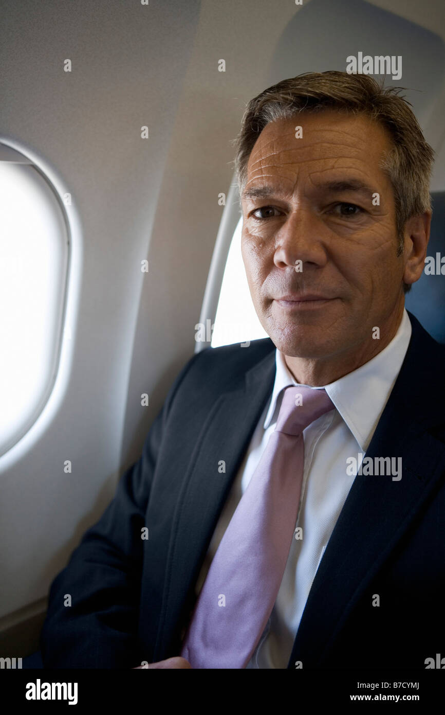 A businessman on a plane, portrait Stock Photo - Alamy