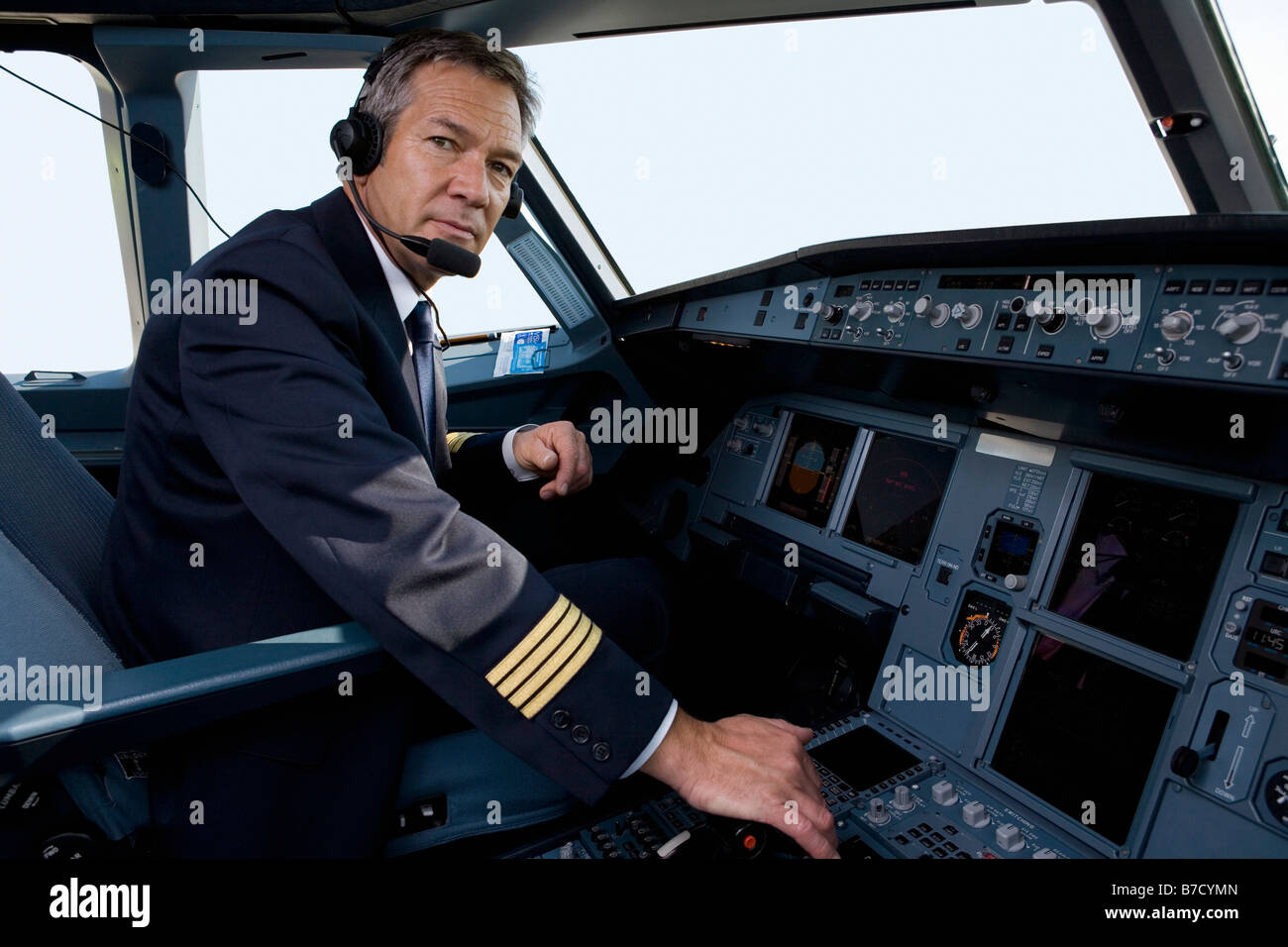 A pilot in the cockpit of a commercial plane Stock Photo - Alamy