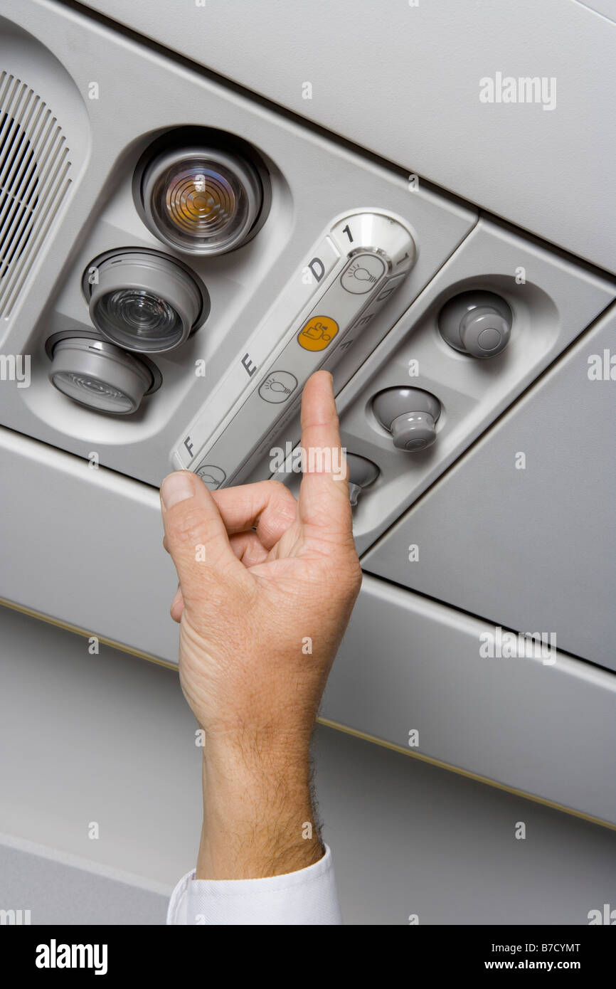 A finger pressing the call button on an airplane Stock Photo - Alamy
