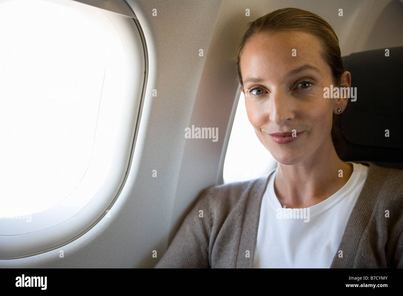 A female passenger on a plane, portrait Stock Photo - Alamy