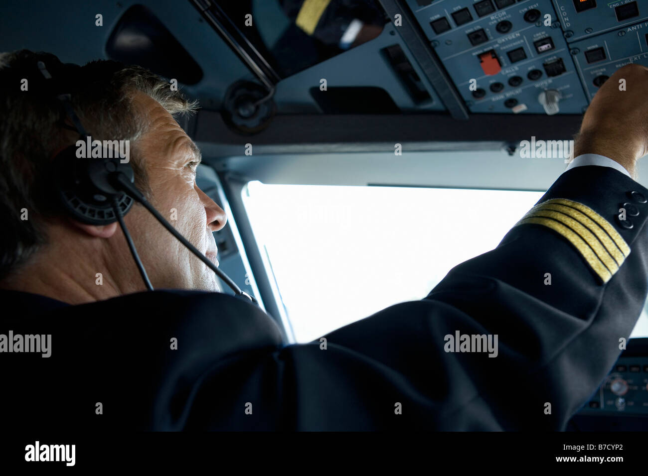 A pilot in the cockpit of a commercial plane Stock Photo - Alamy