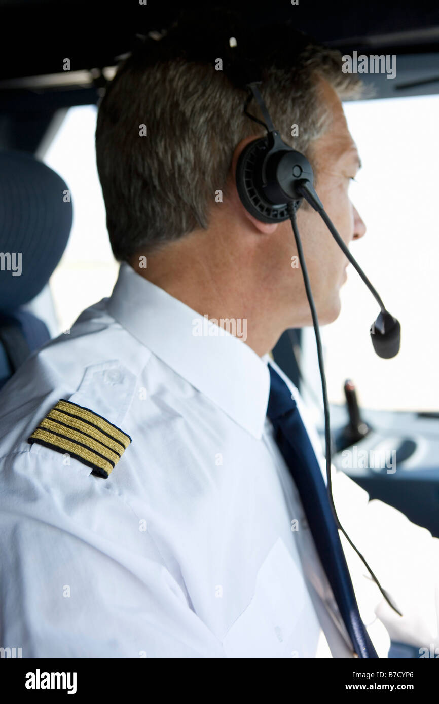 A pilot in the cockpit of a commercial plane Stock Photo - Alamy