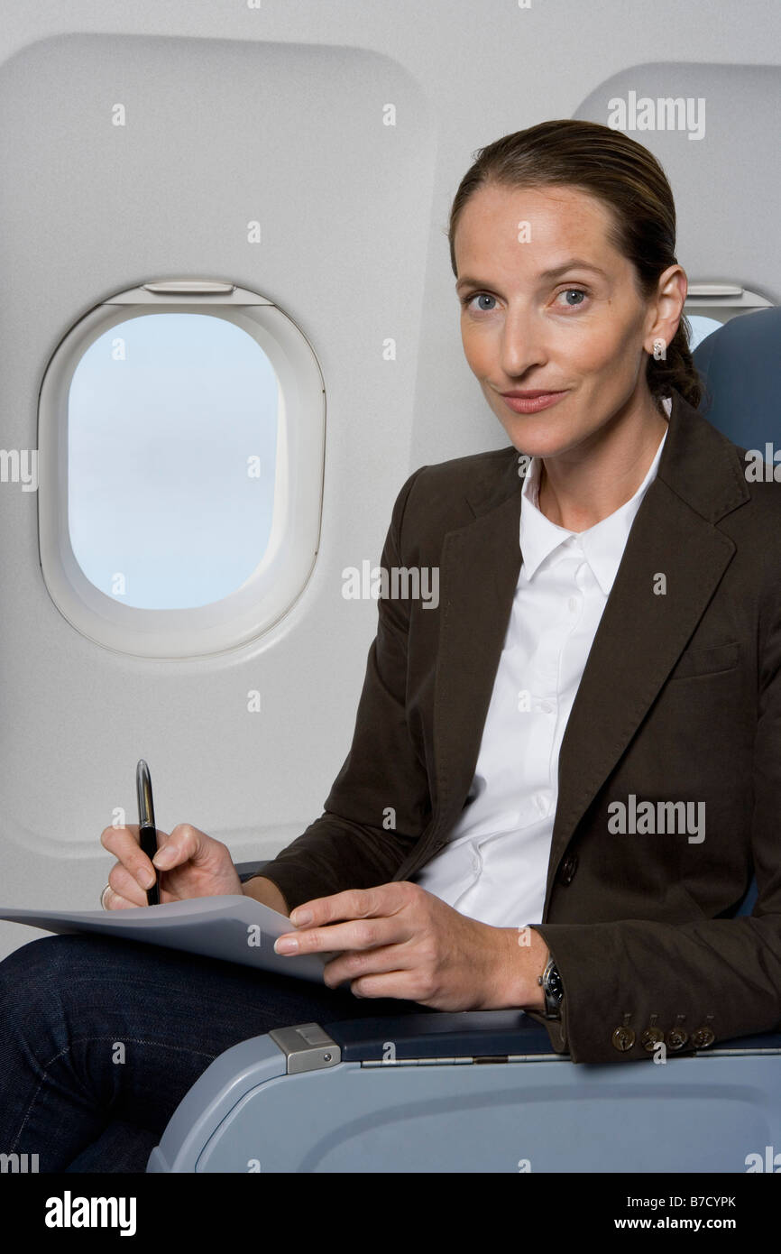 A businesswoman working on a plane Stock Photo - Alamy