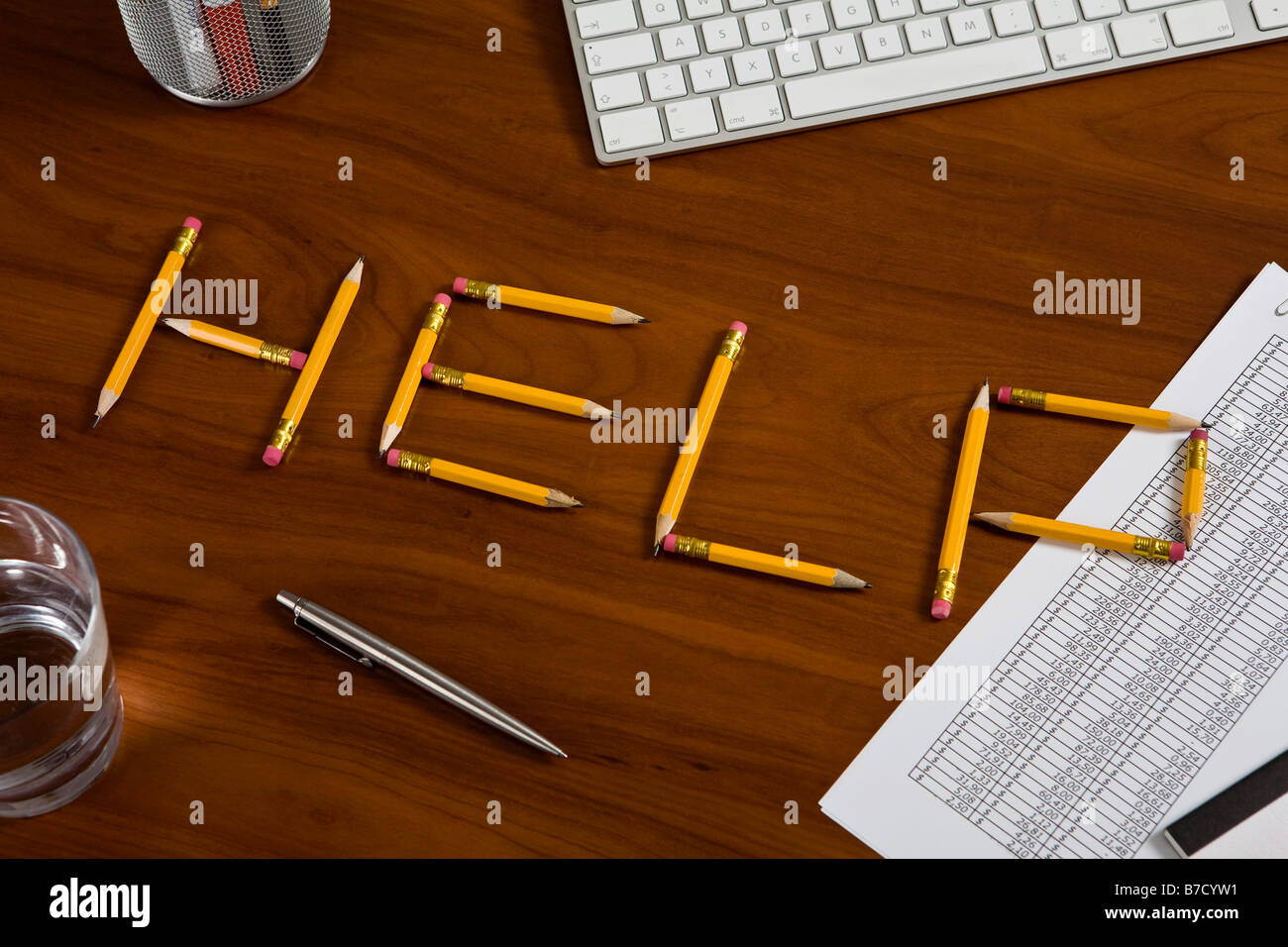 Pencils on a desk arranged to spell Help Stock Photo - Alamy