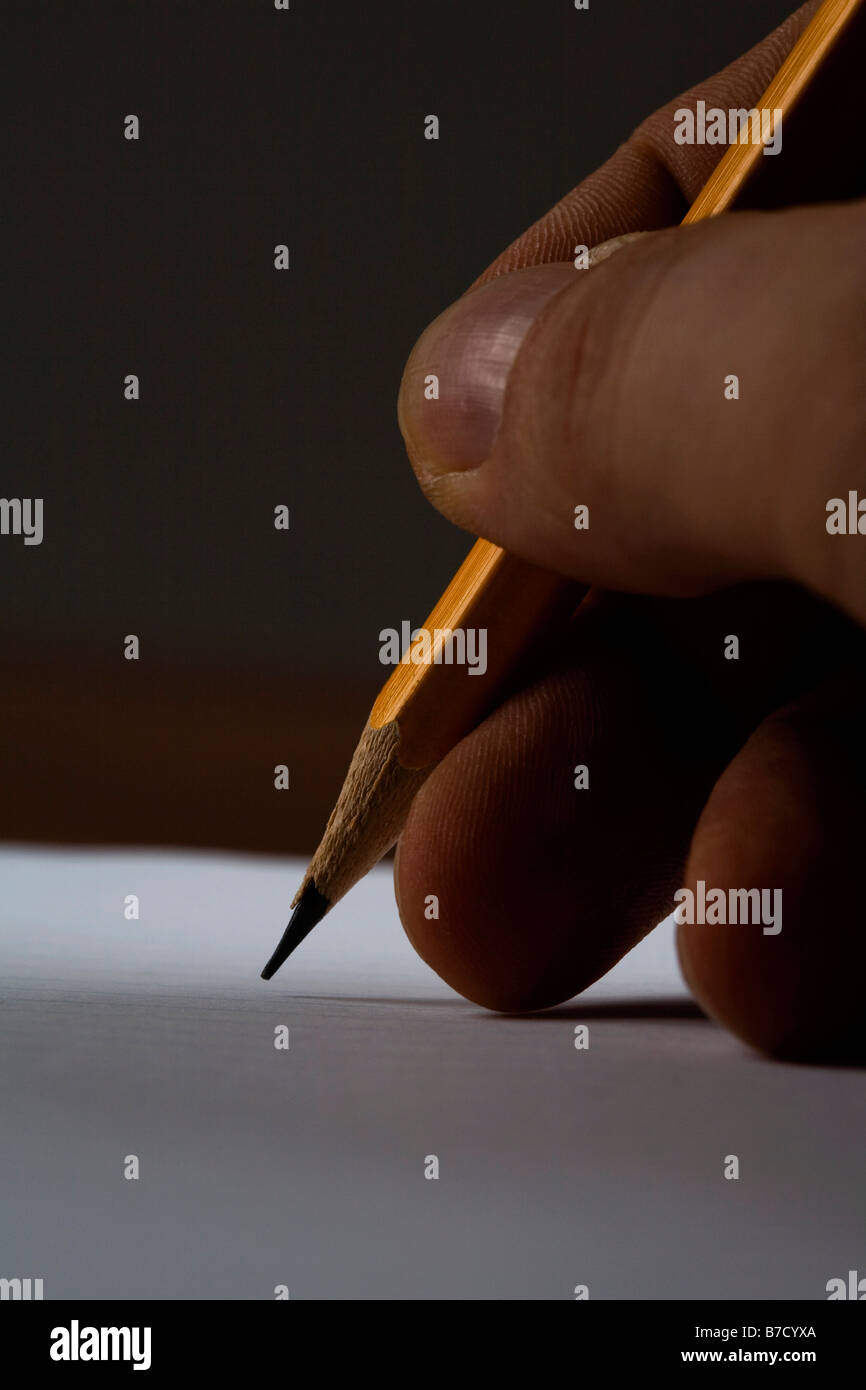 Extreme close-up of a handing holding a pencil Stock Photo - Alamy