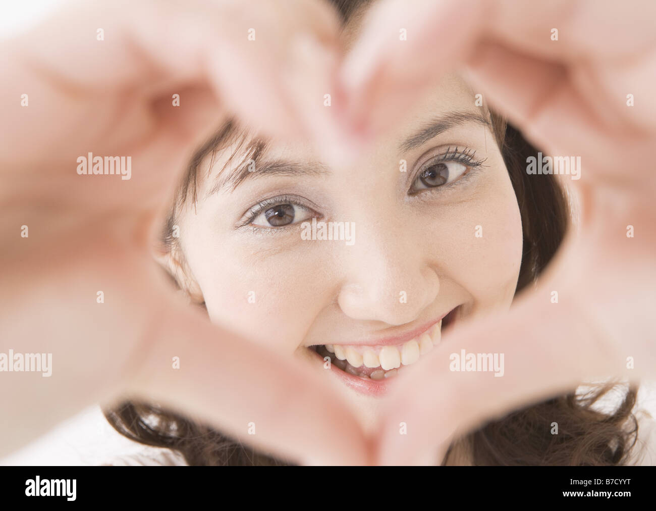 Woman making heart shape with hands Stock Photo - Alamy