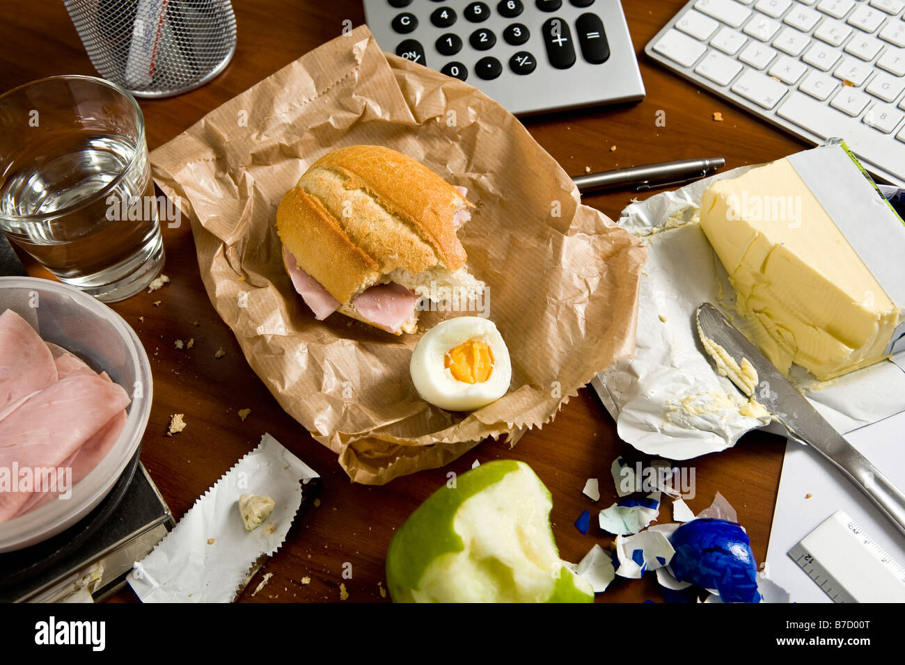 An office desk cluttered with food Stock Photo - Alamy