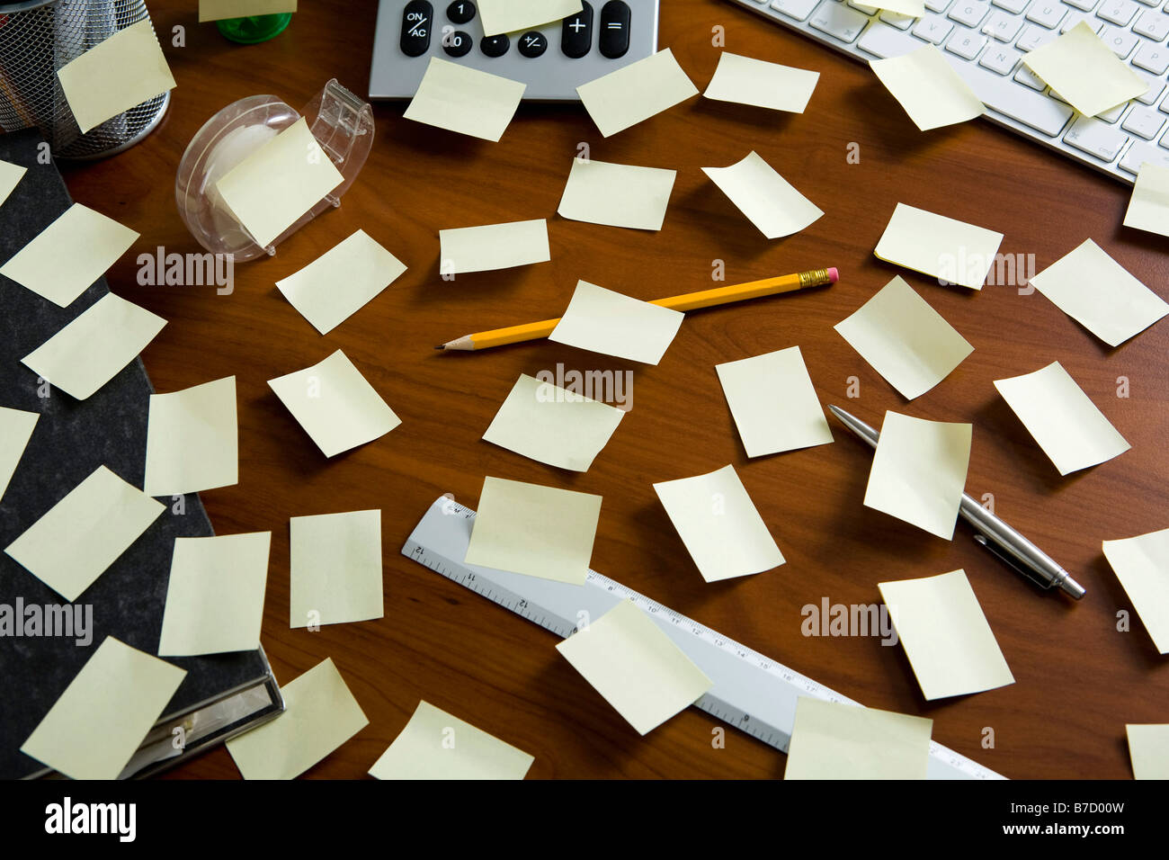 An office desk cluttered with adhesive notes and office supplies Stock ...