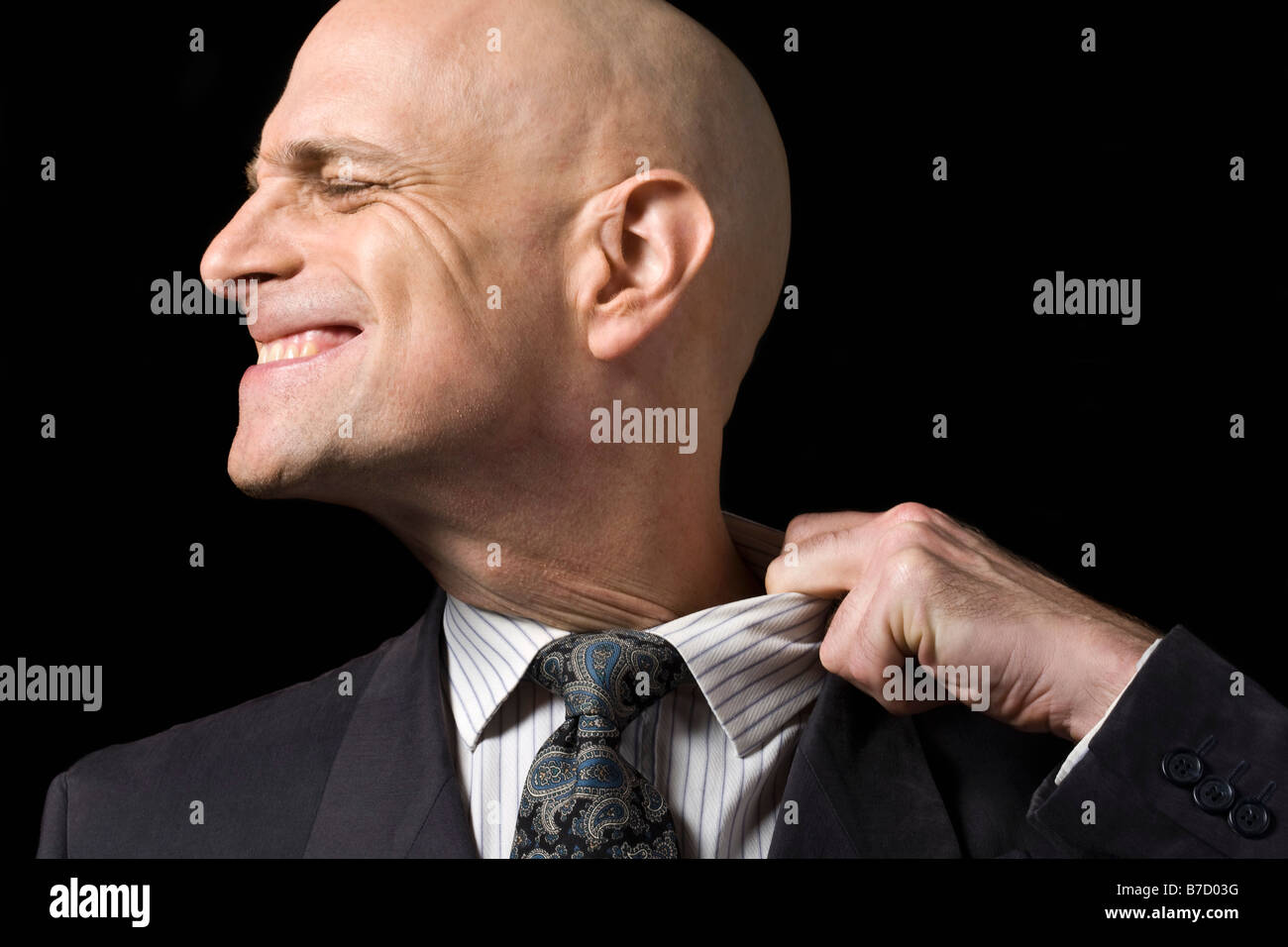 A business man pulling at his collar Stock Photo - Alamy
