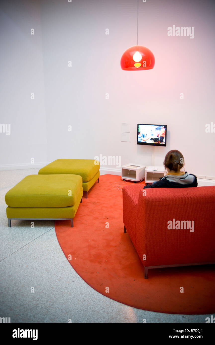 Girl watching TV on couch rear view Stock Photo - Alamy
