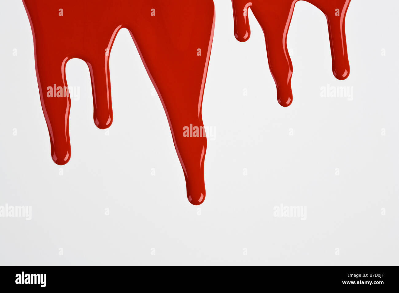 Red paint dripping down a white wall Stock Photo - Alamy