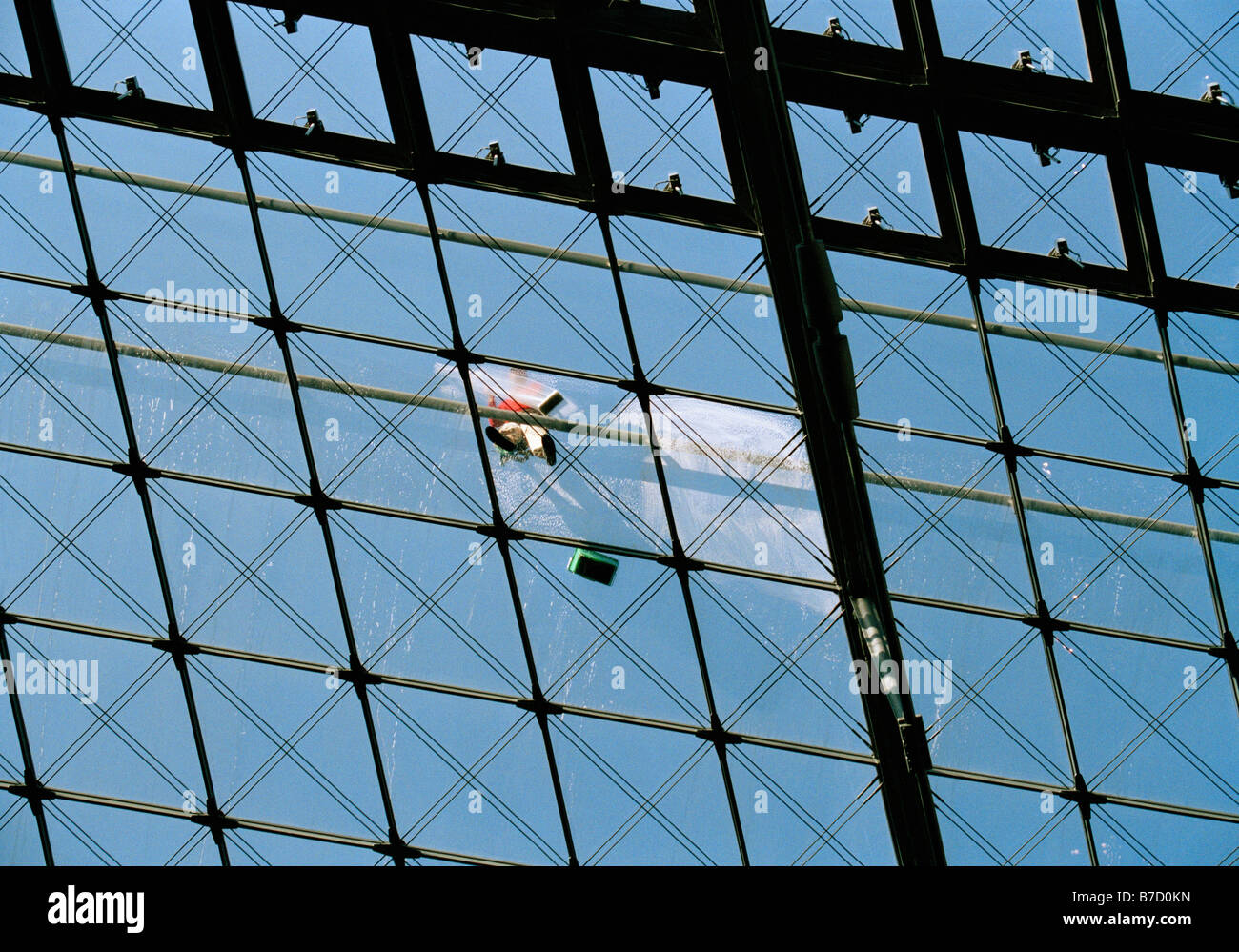 A window cleaner standing on a glass roof Stock Photo - Alamy