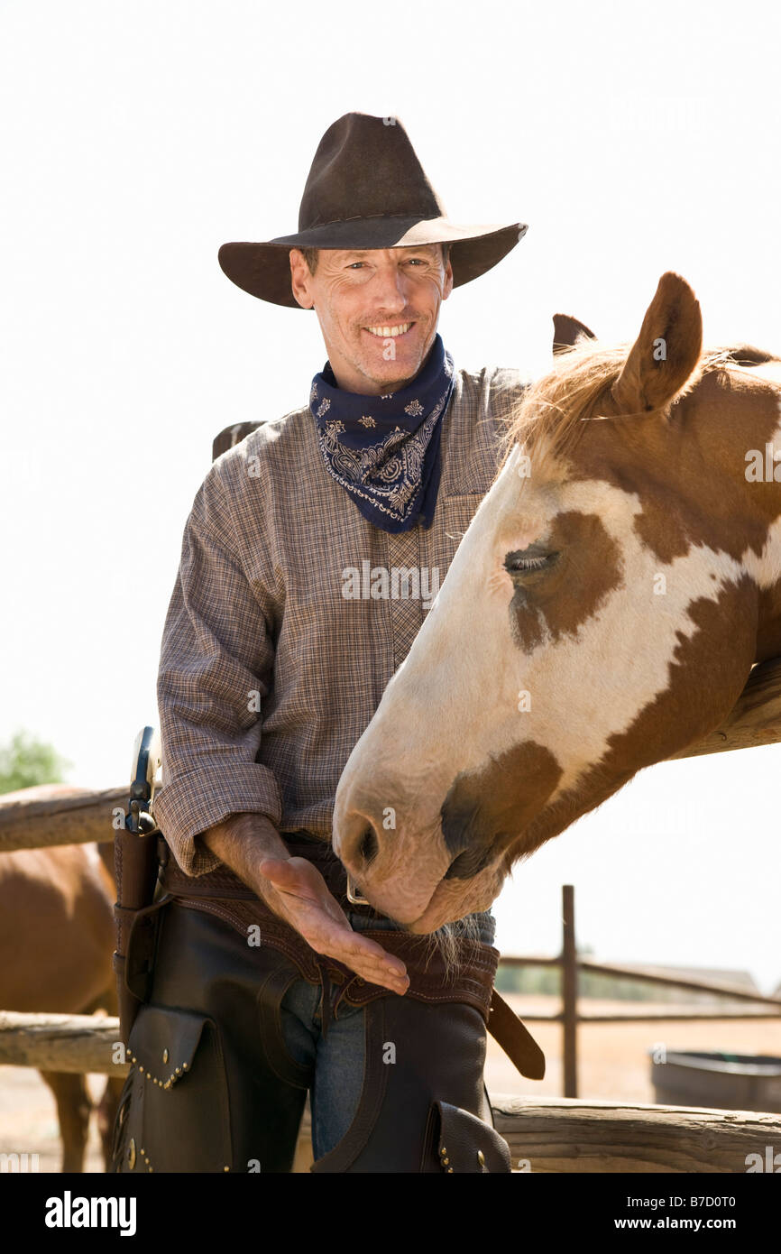 A rancher standing with his horse Stock Photo - Alamy