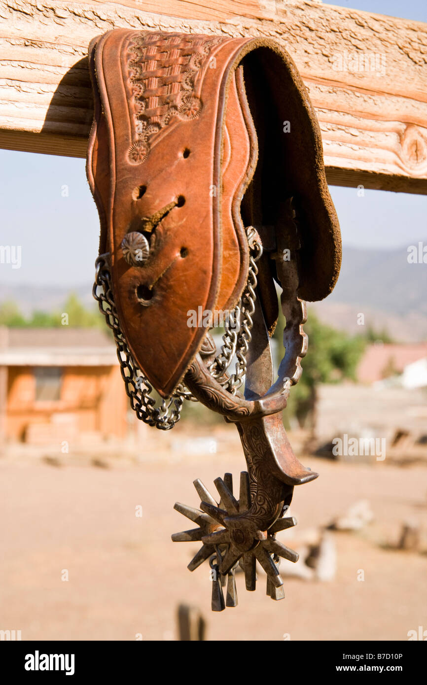 Spurs hanging from a fence Stock Photo - Alamy