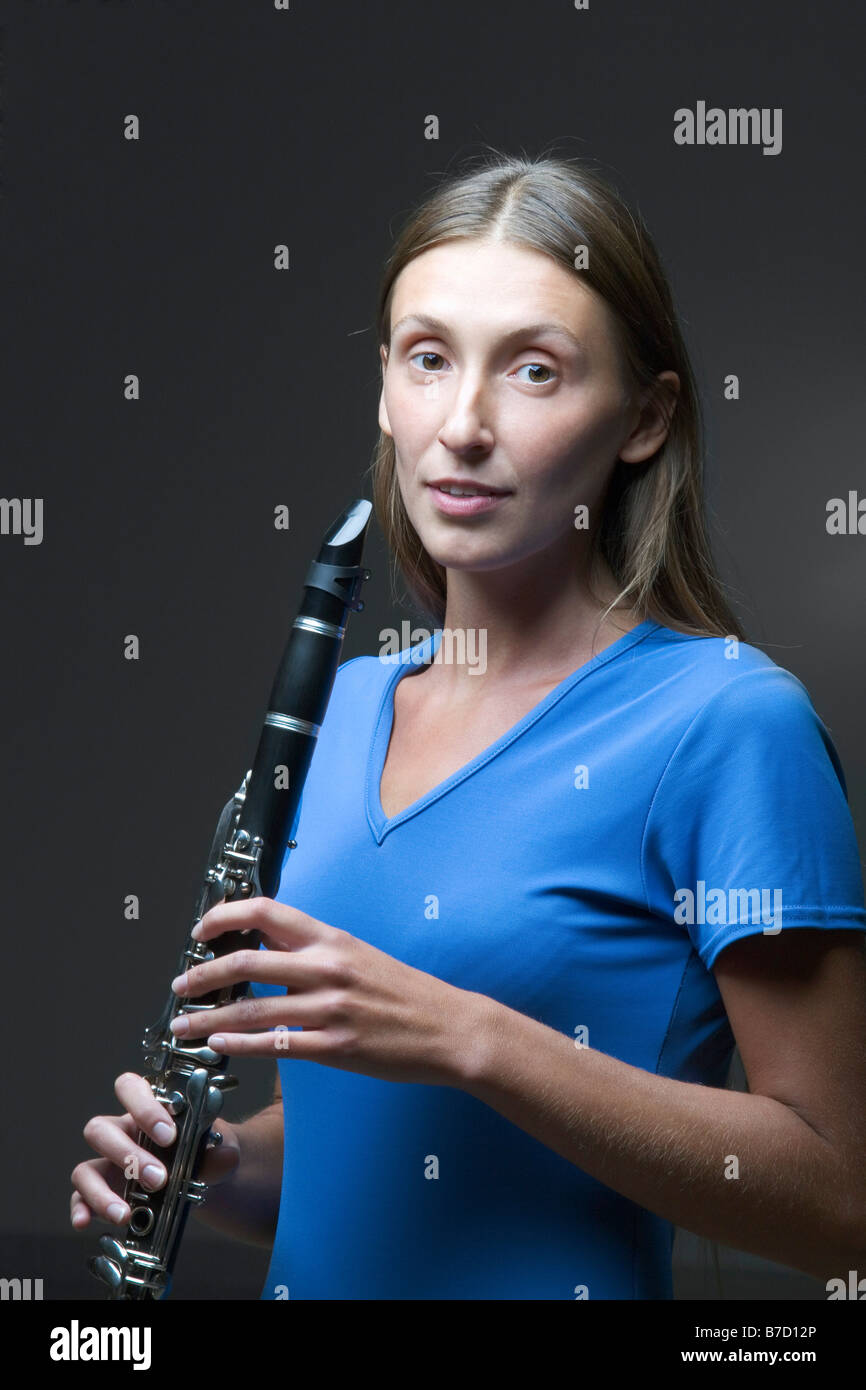 A young woman holding a clarinet Stock Photo - Alamy