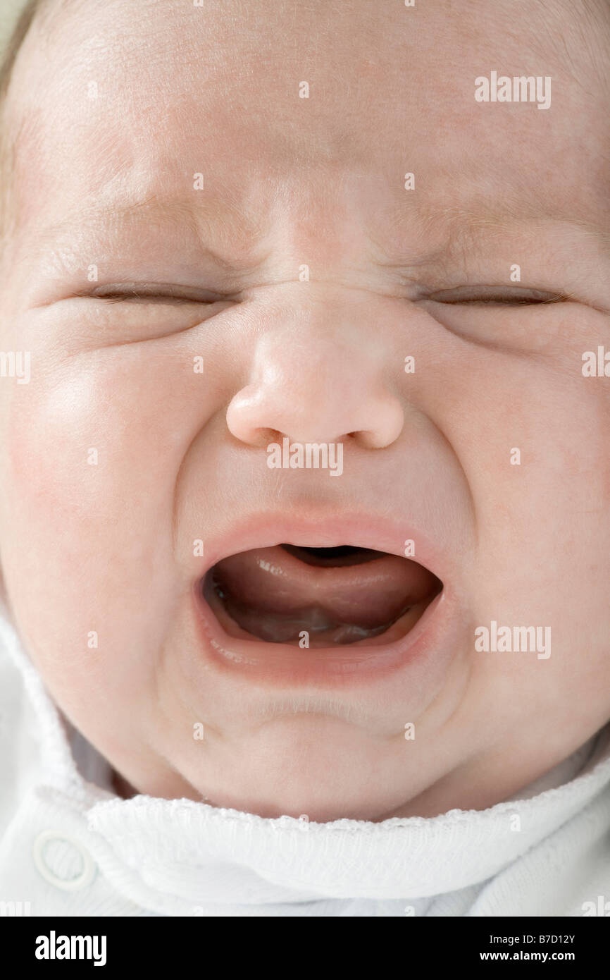 A crying newborn baby Stock Photo - Alamy