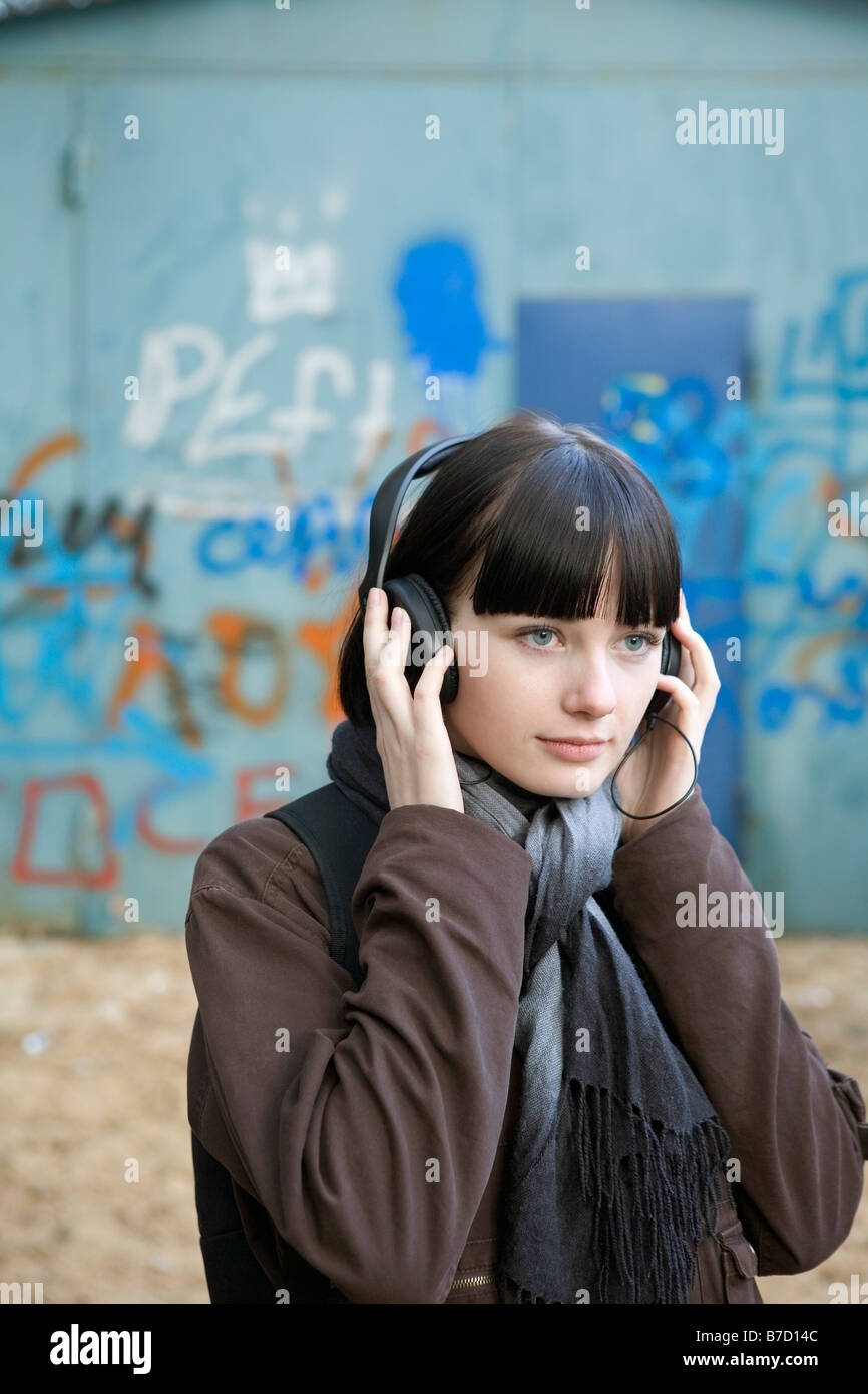 A teenage girl wearing headphones, outdoors Stock Photo - Alamy
