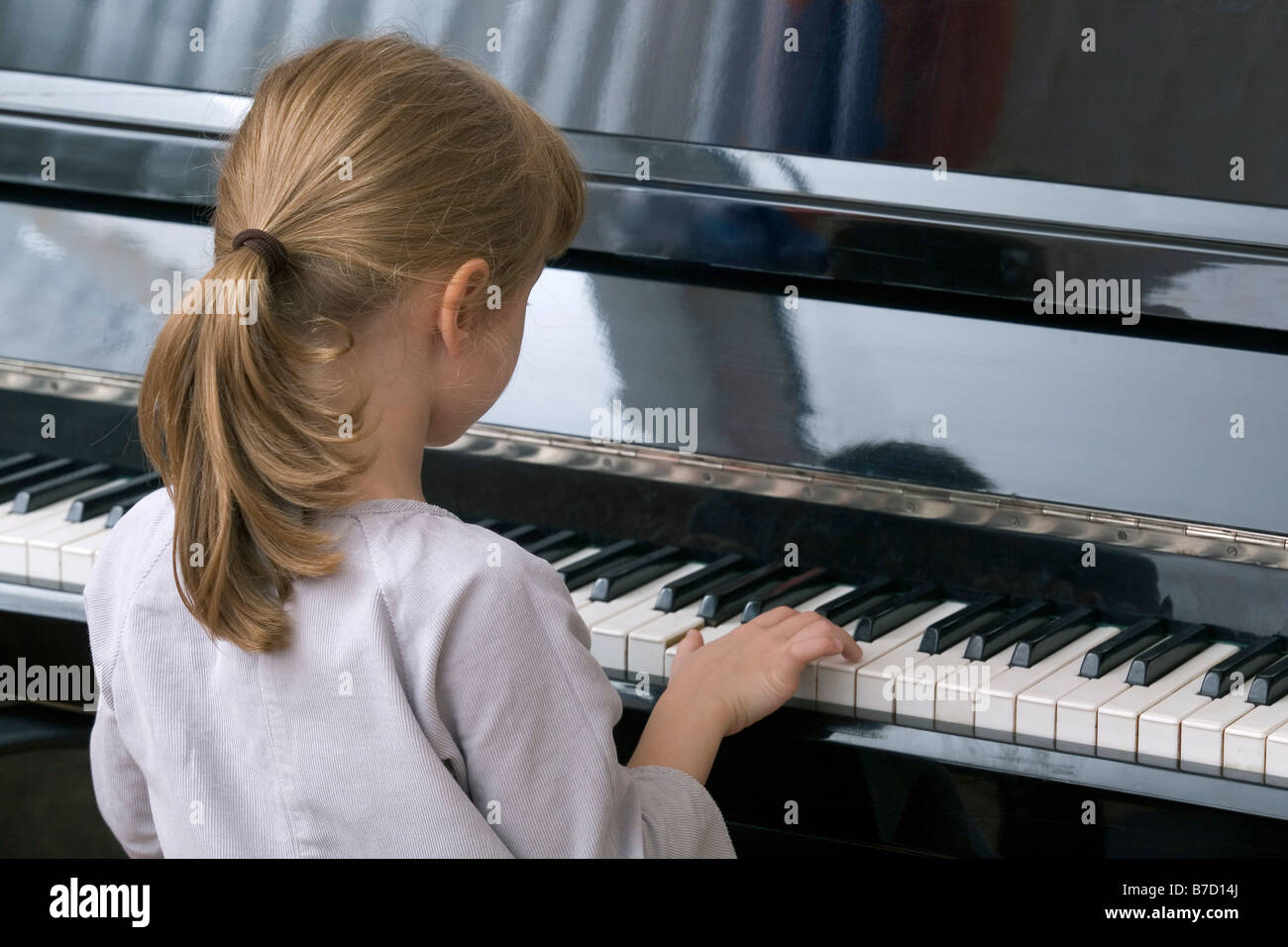 A young girl playing piano Stock Photo - Alamy