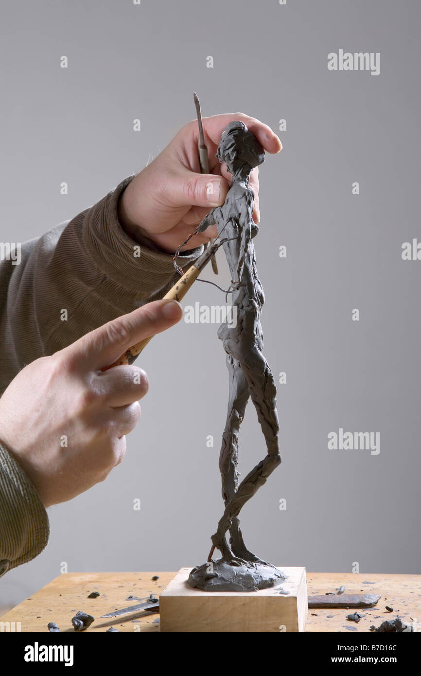 Human hands working on a sculpture Stock Photo - Alamy
