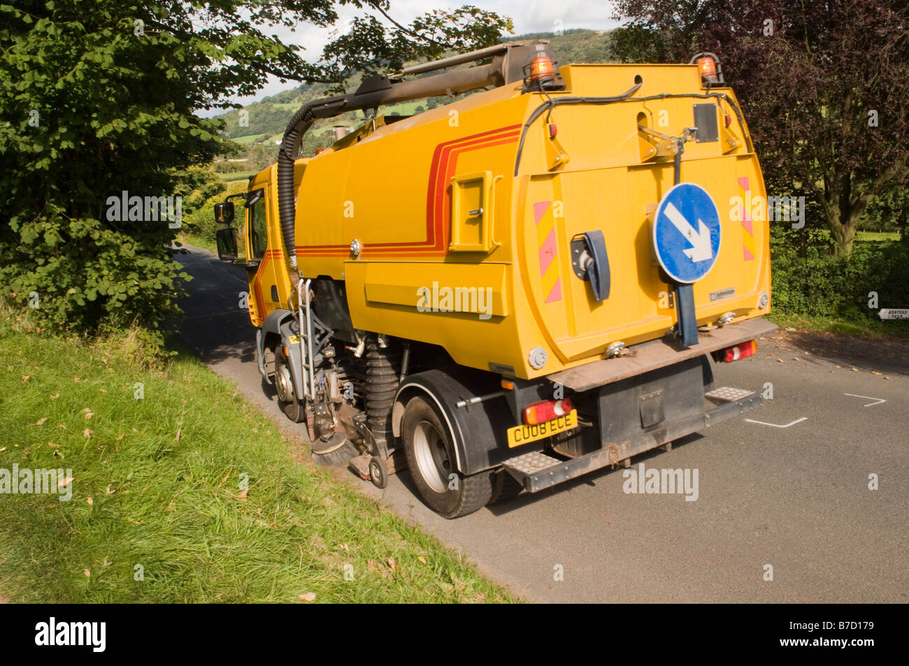 mechanical road sweeper working on a road Stock Photo - Alamy