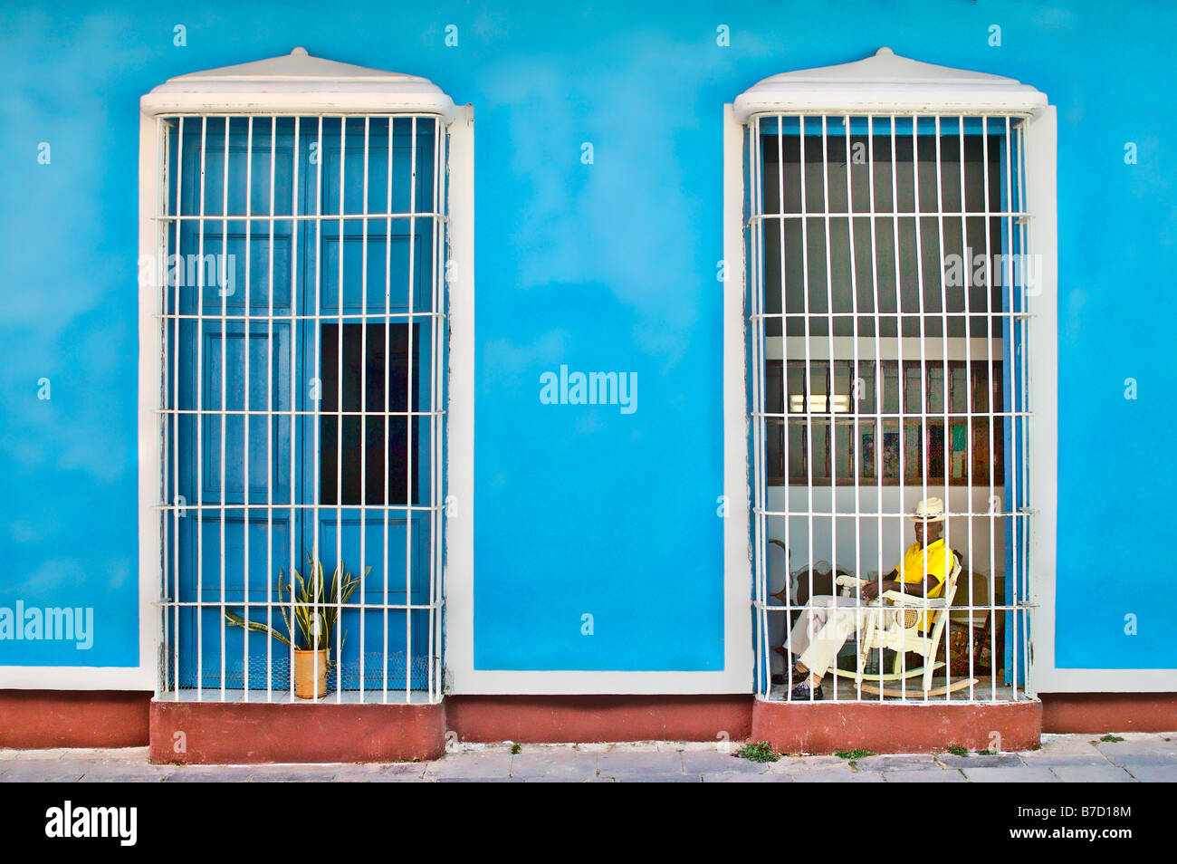 Man sitting behind barred window Trinidad Cuba Stock Photo - Alamy