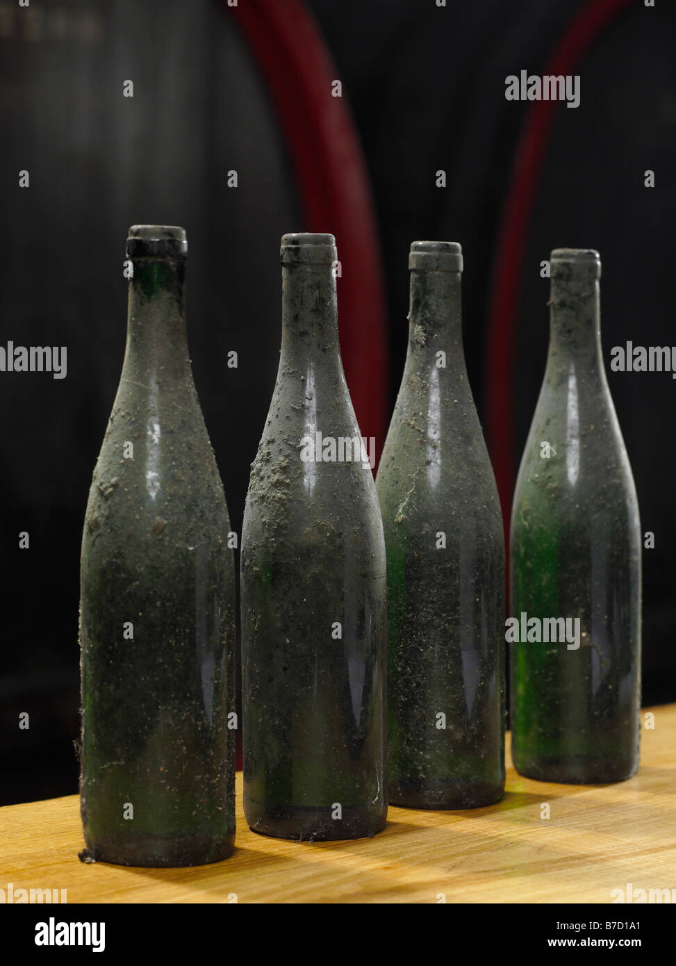 Four dusty wine bottles in a winery Stock Photo - Alamy