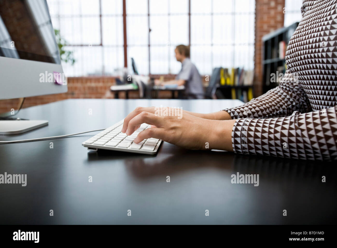 A woman using a computer in an office Stock Photo - Alamy