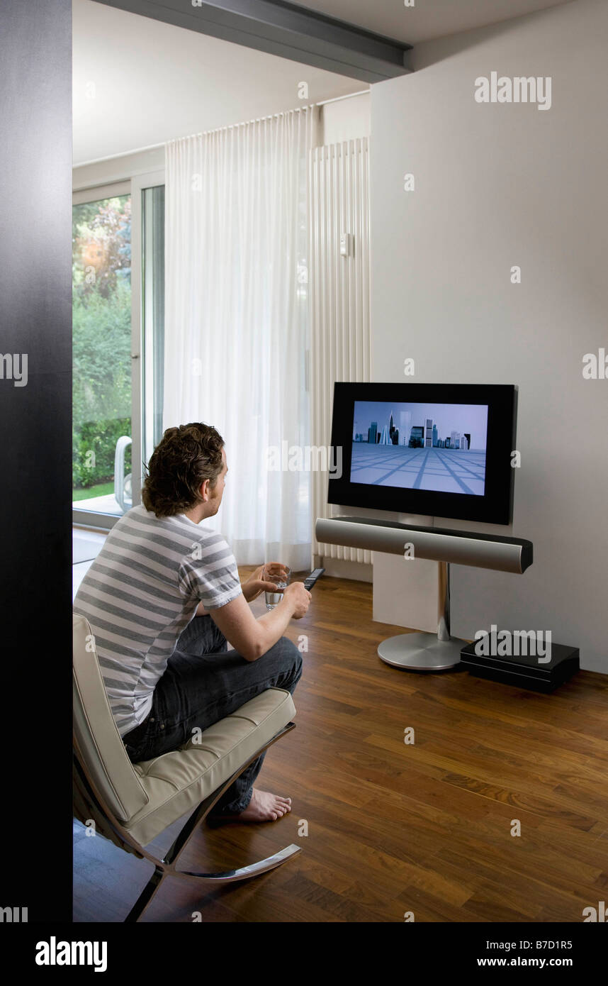 Man watching television Stock Photo - Alamy