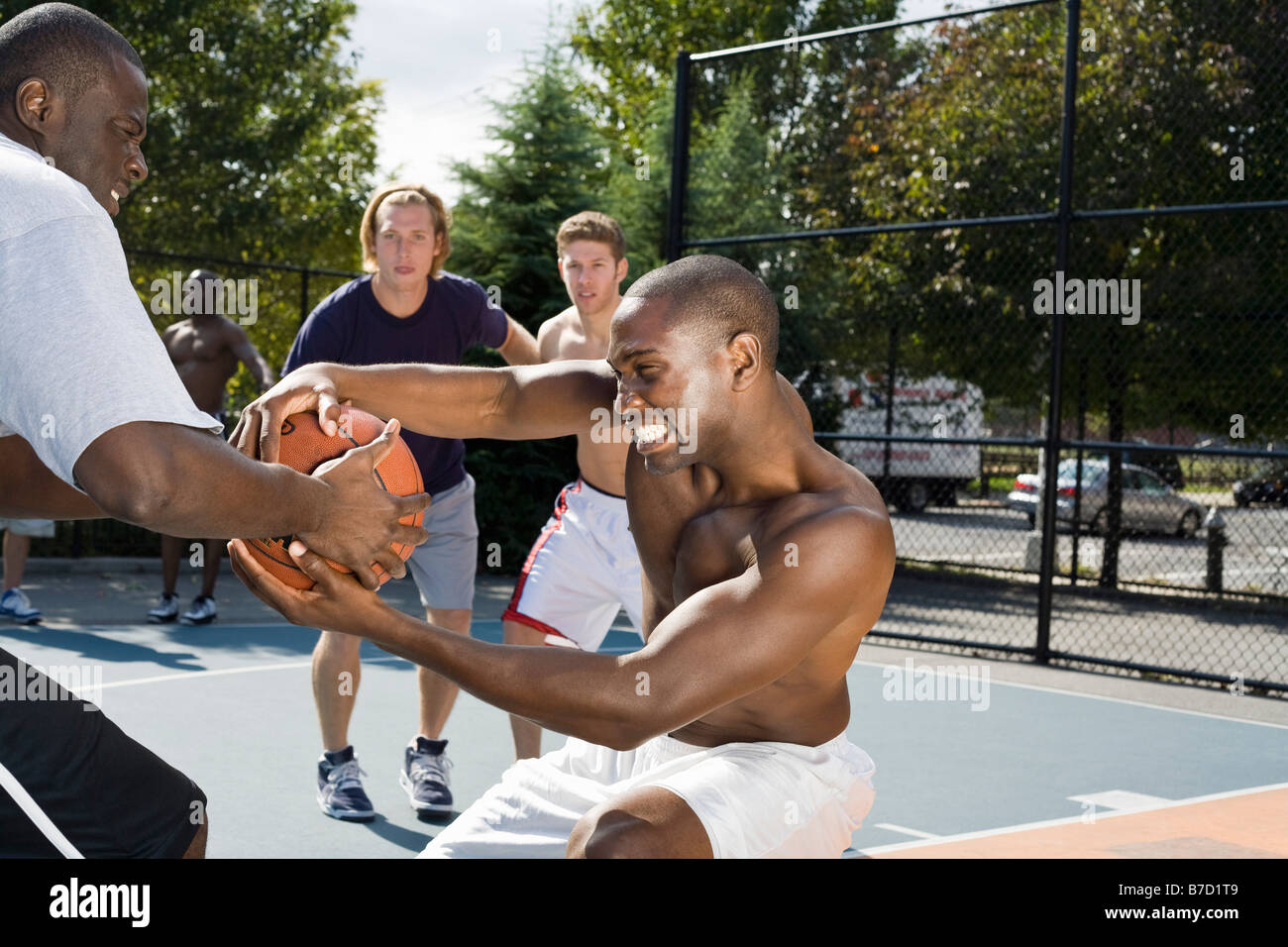 Two basketball players fighting over a basketball Stock Photo - Alamy