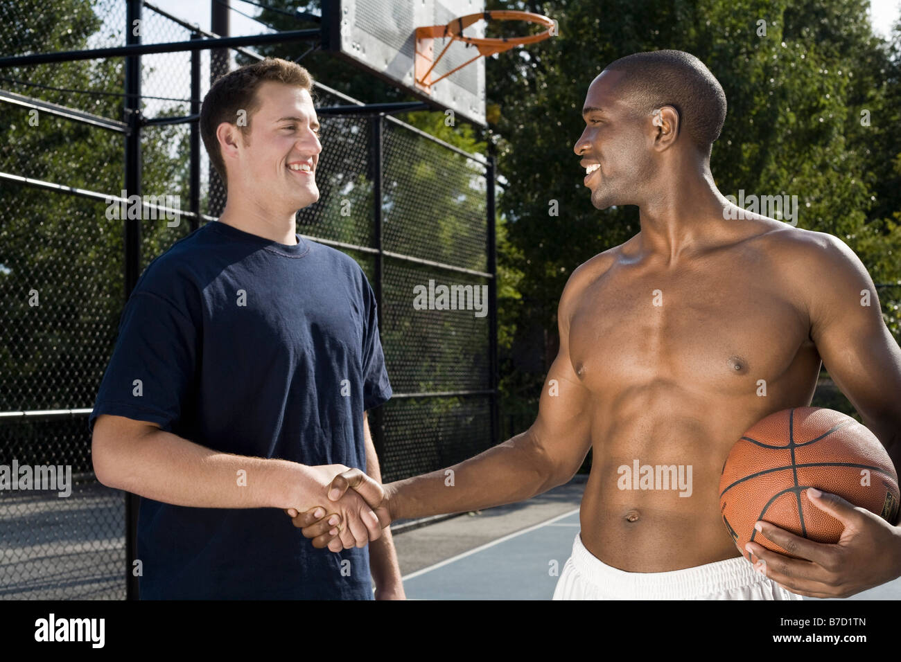 Two basketball players shaking hands Stock Photo - Alamy