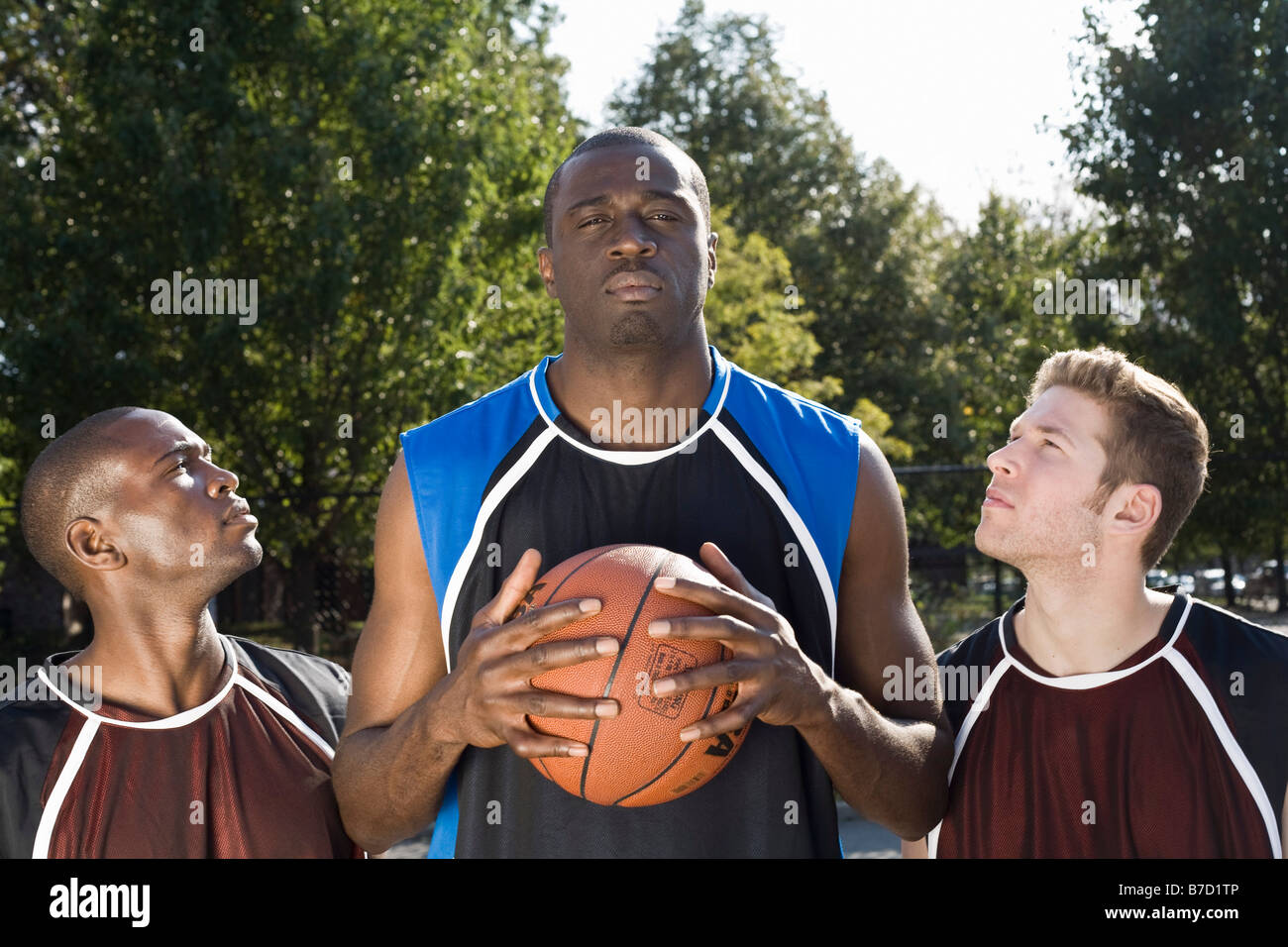 Three basketball players, in a row Stock Photo - Alamy