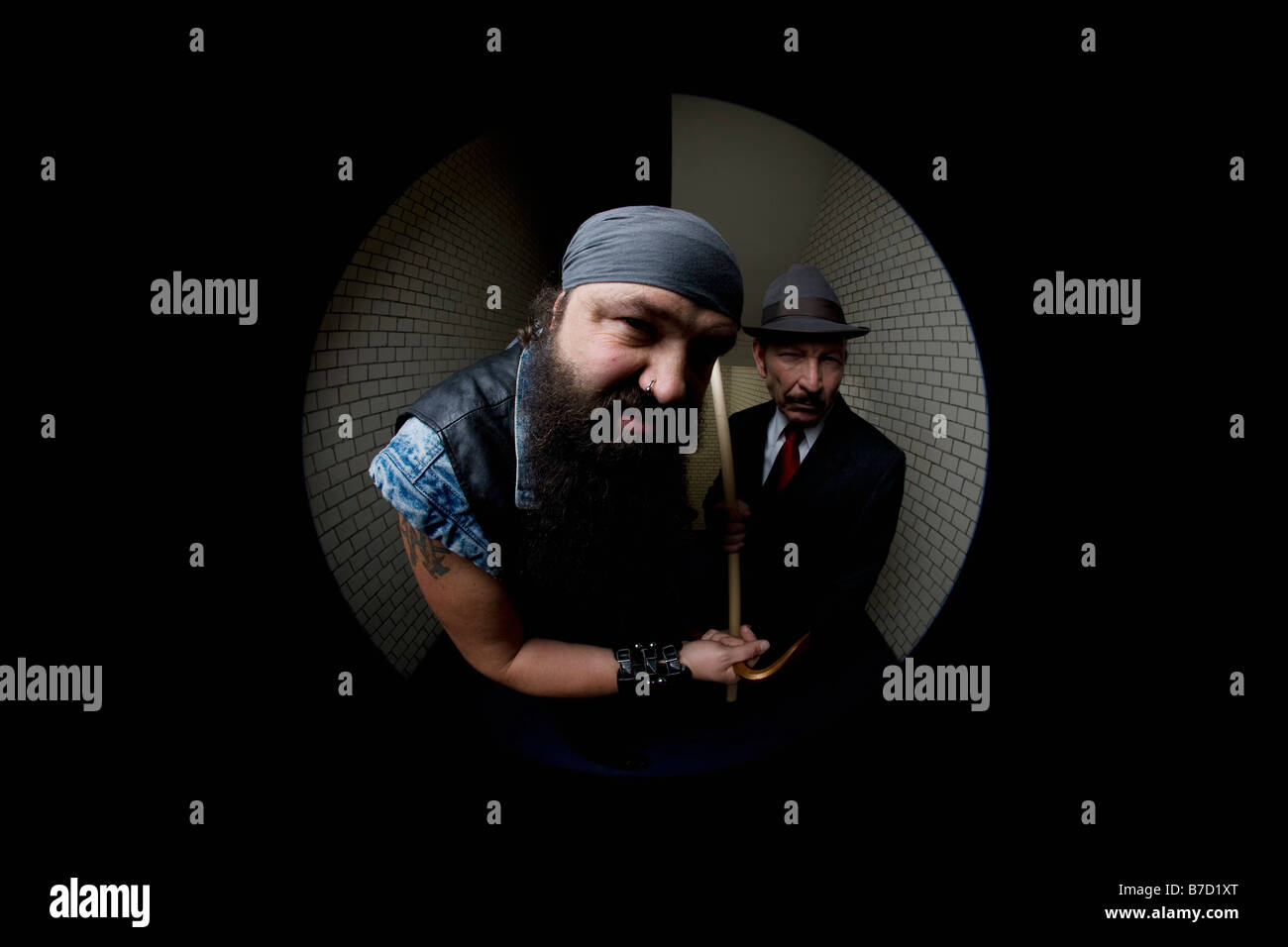 An organized crime boss with his bodyguard, viewed through a peephole ...