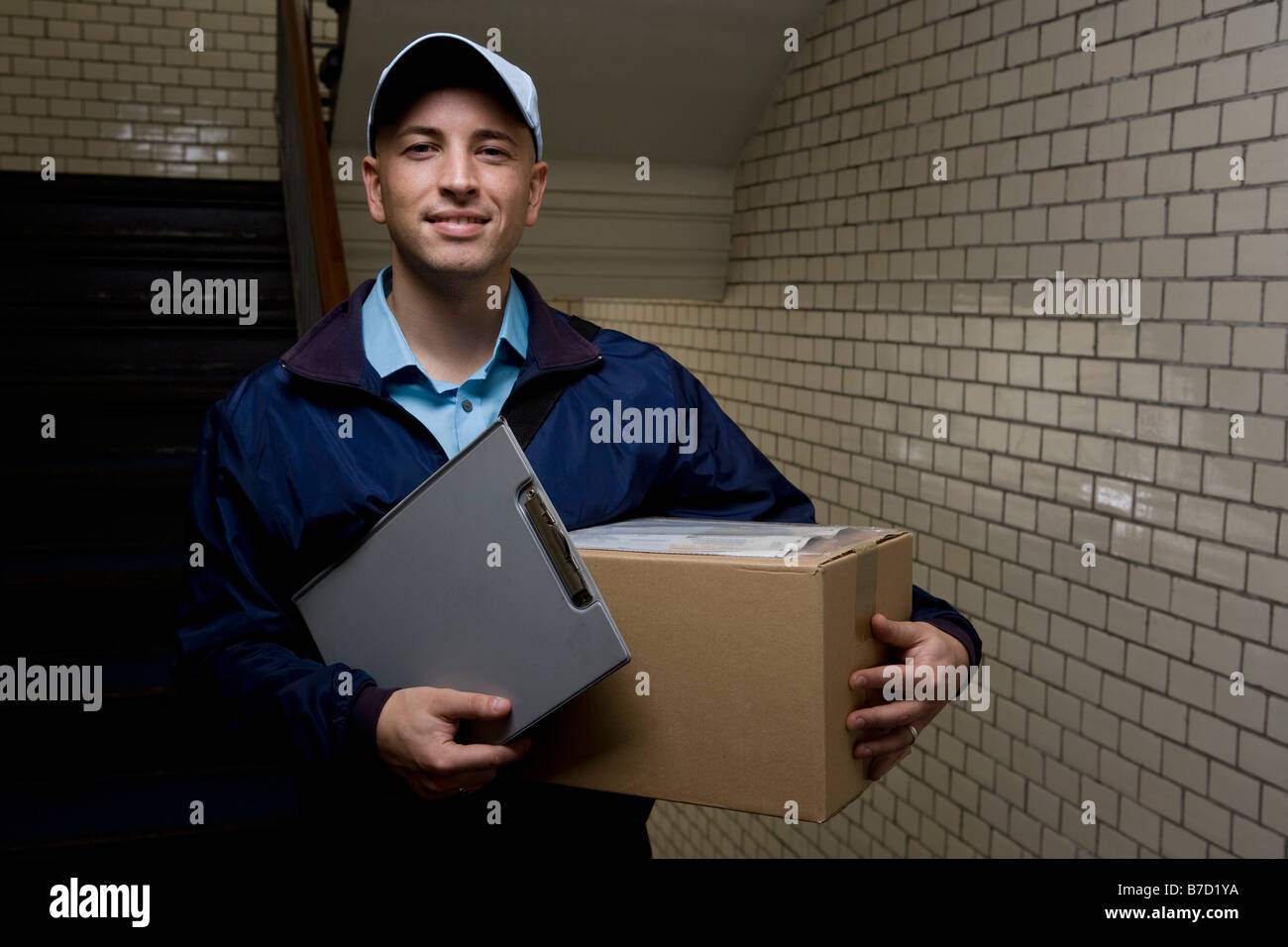 A delivery man with a package Stock Photo - Alamy