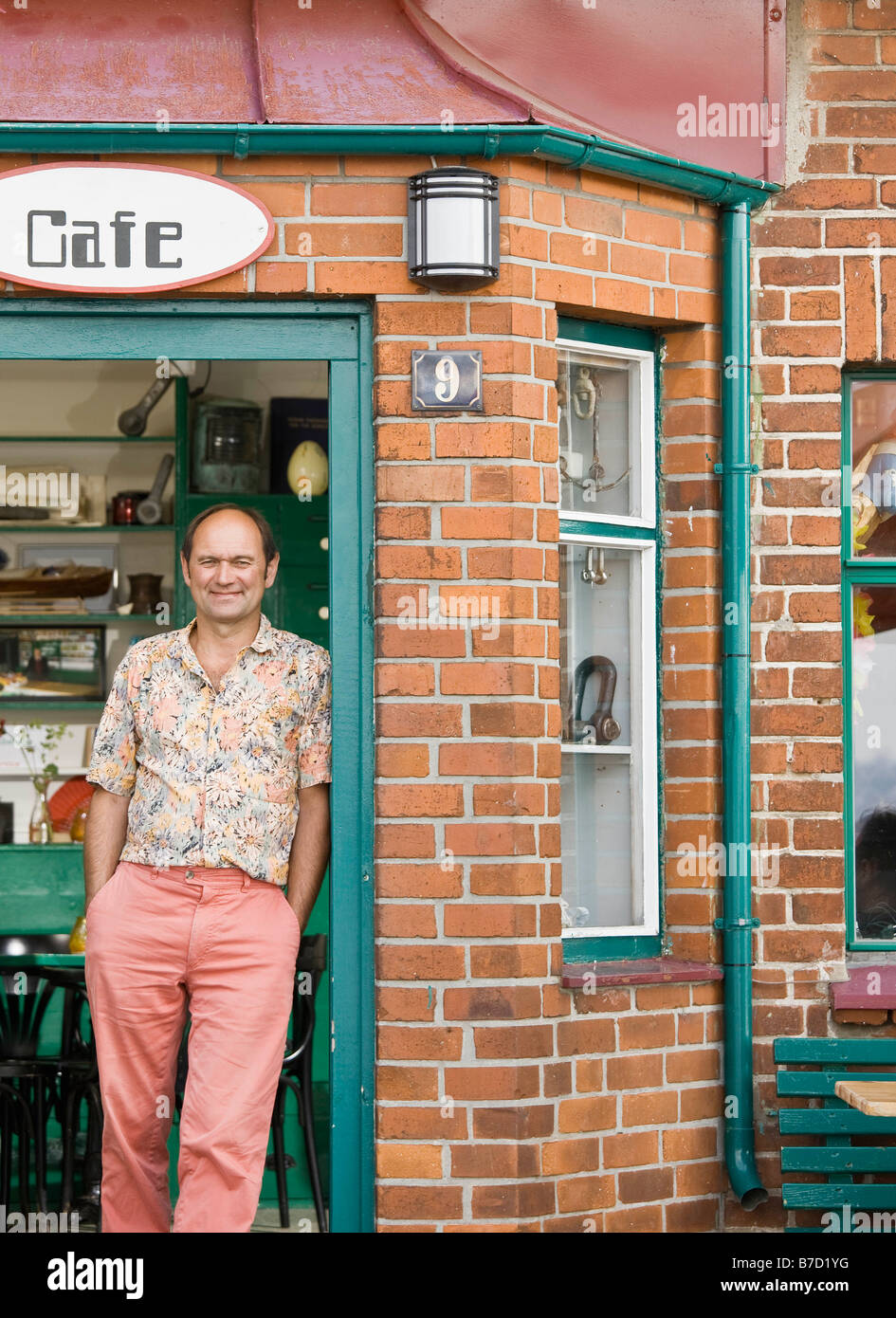 Man standing in front of a cafe Stock Photo - Alamy