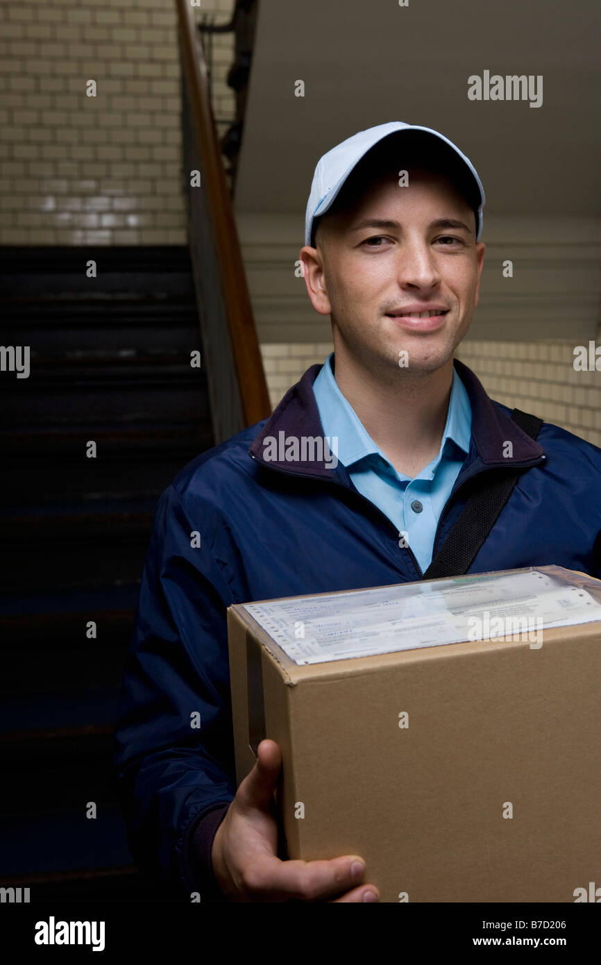 A delivery man with a package Stock Photo - Alamy