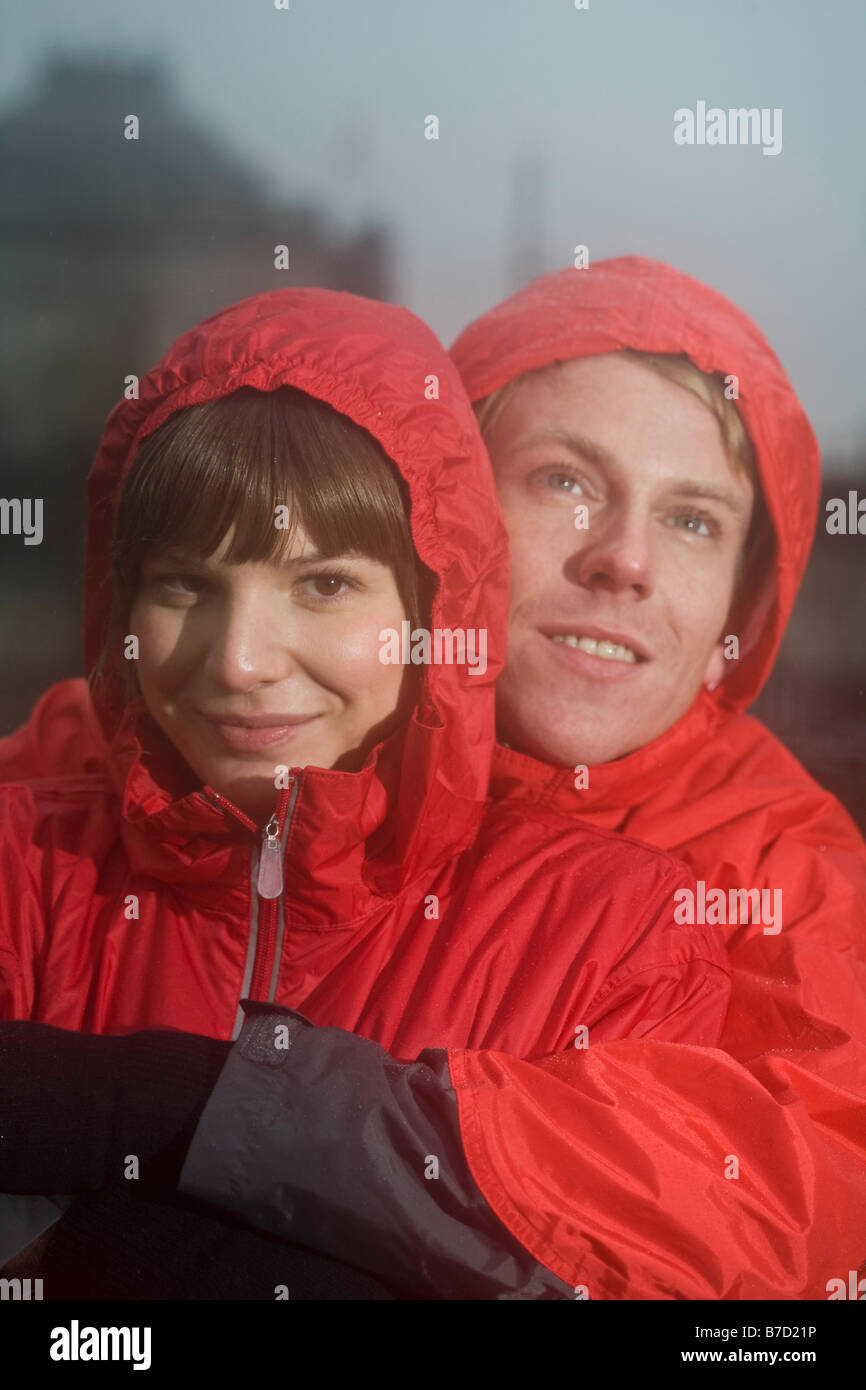 Young couple wearing raincoats Stock Photo - Alamy