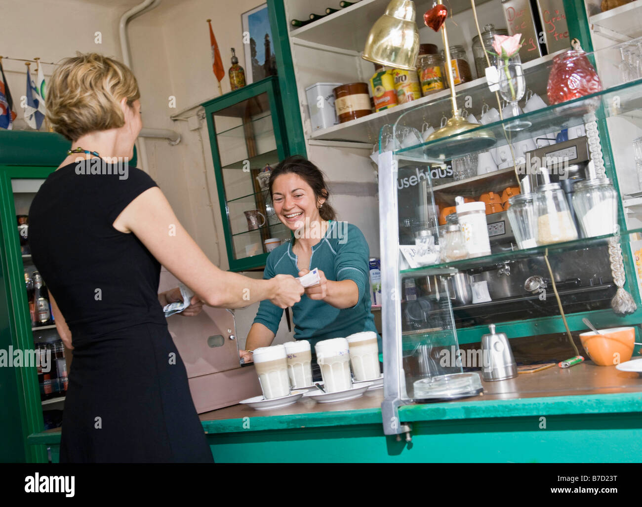 Female barista helping a female customer Stock Photo - Alamy