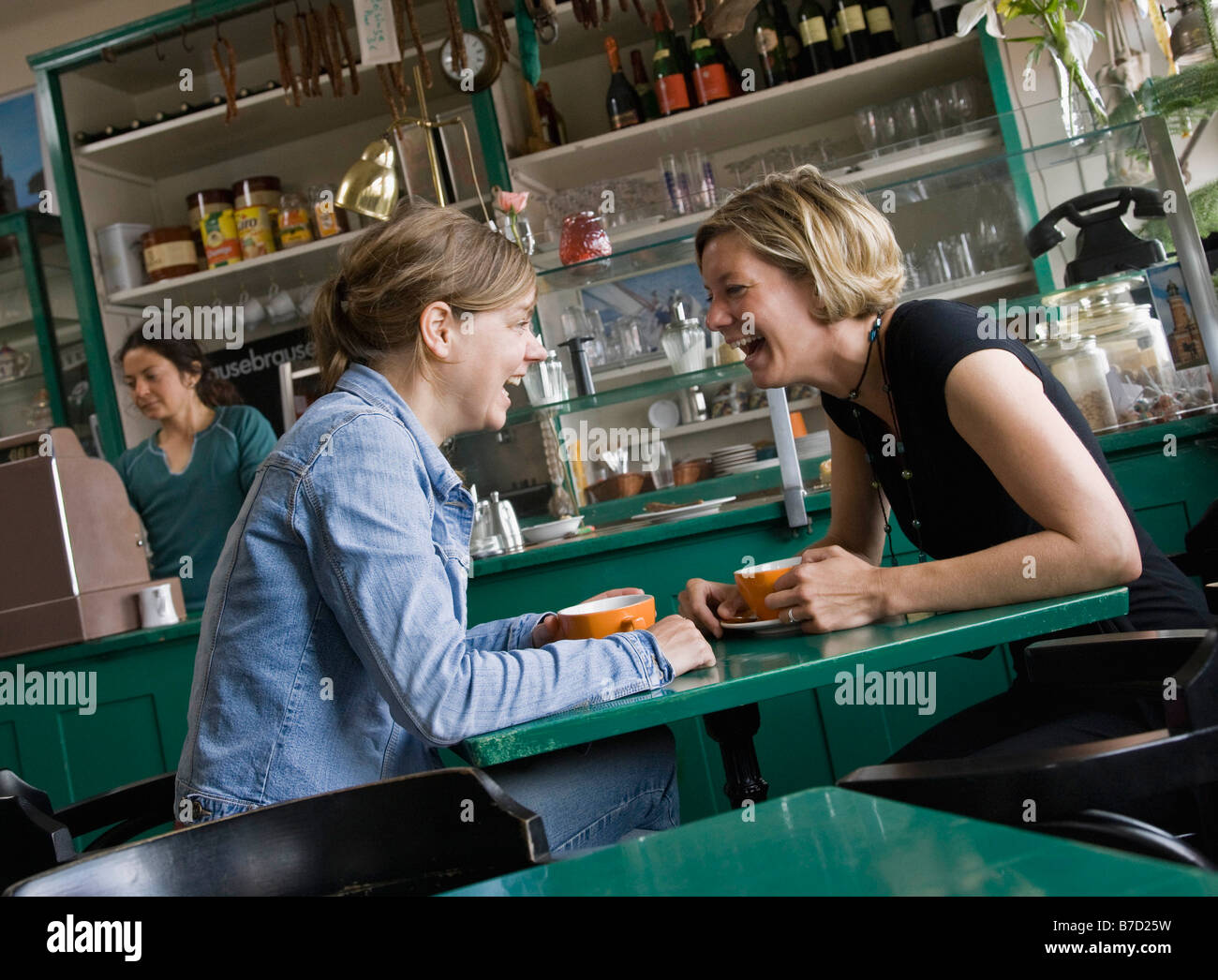 Women talking over coffee at a cafe Stock Photo - Alamy