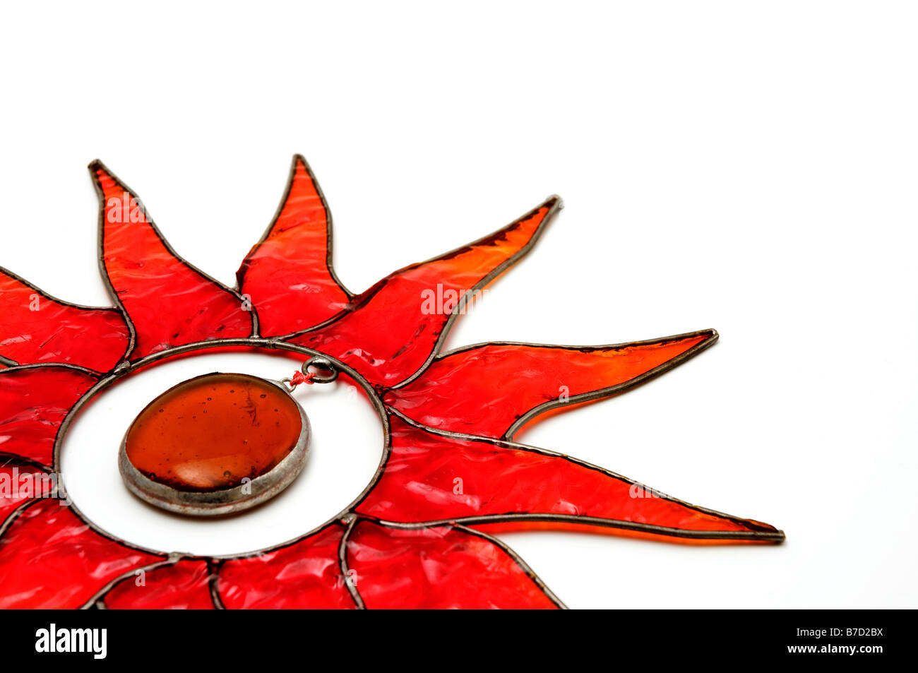 Sun shaped glass decoration on a white background Stock Photo - Alamy