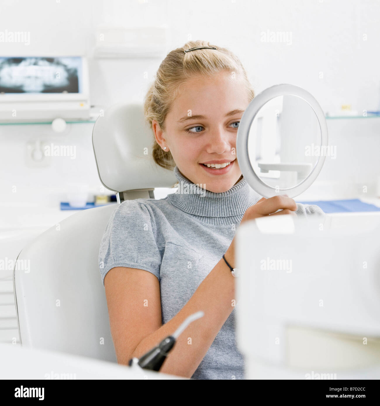 Dental patient looking at a mirror Stock Photo - Alamy
