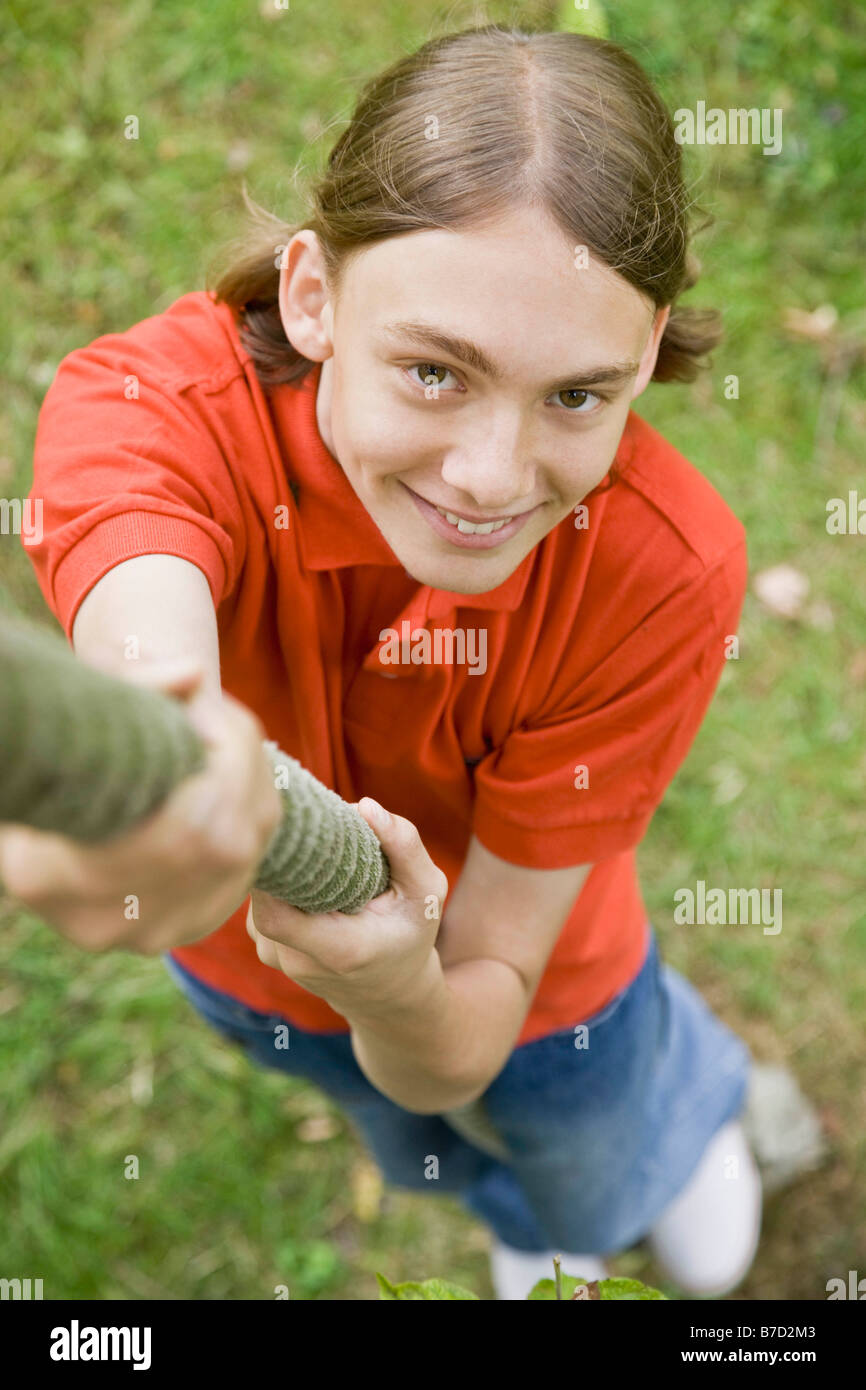 Young boy climbing on a tree rope Stock Photo - Alamy