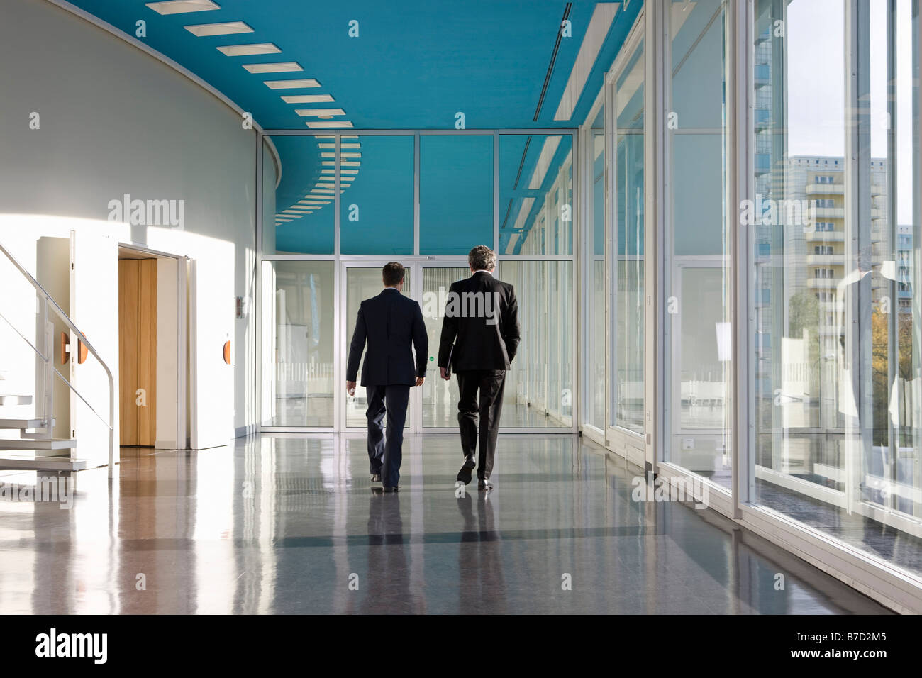 Two businessmen walking towards the exit Stock Photo - Alamy