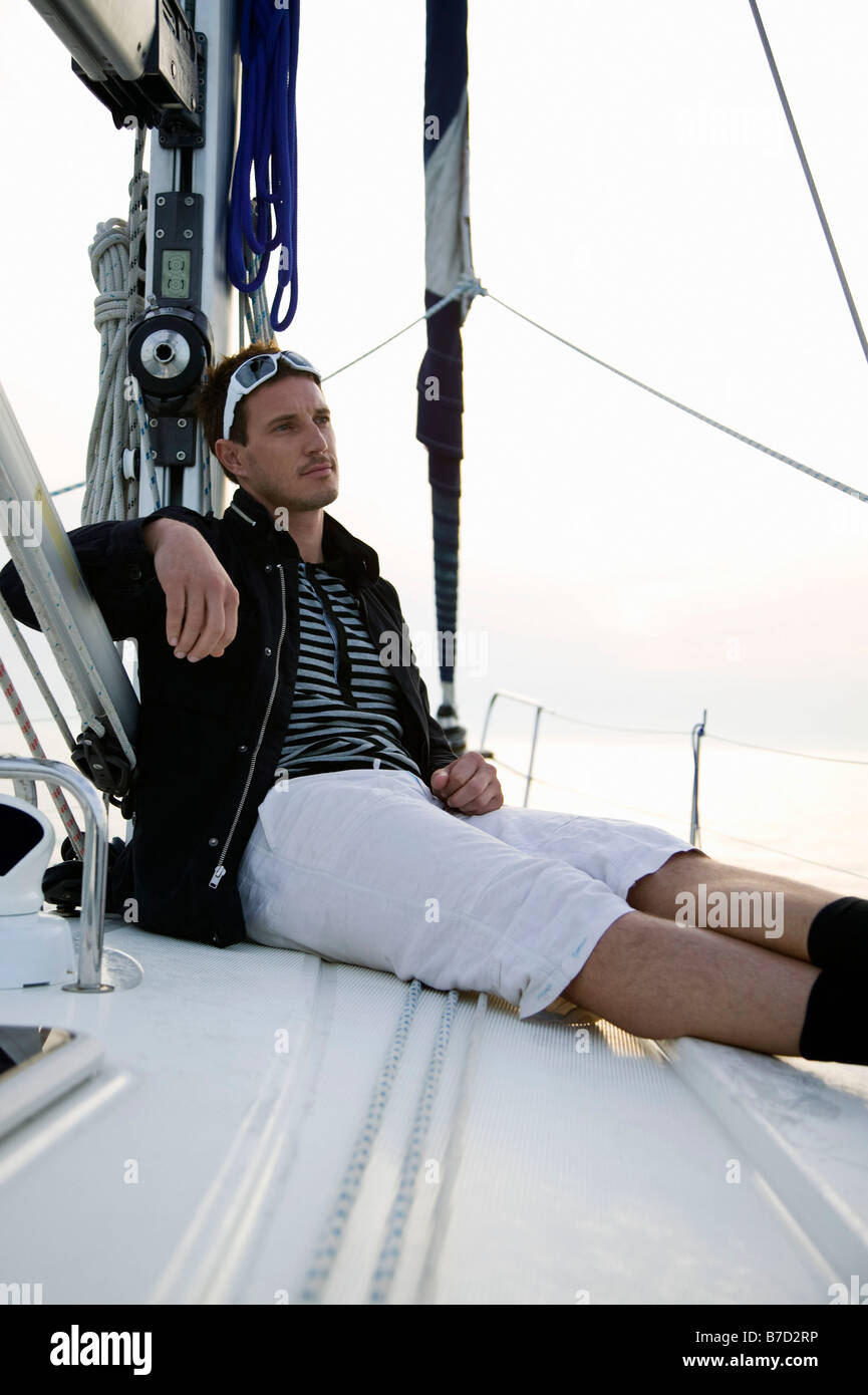 A man sitting on deck of a yacht Stock Photo - Alamy